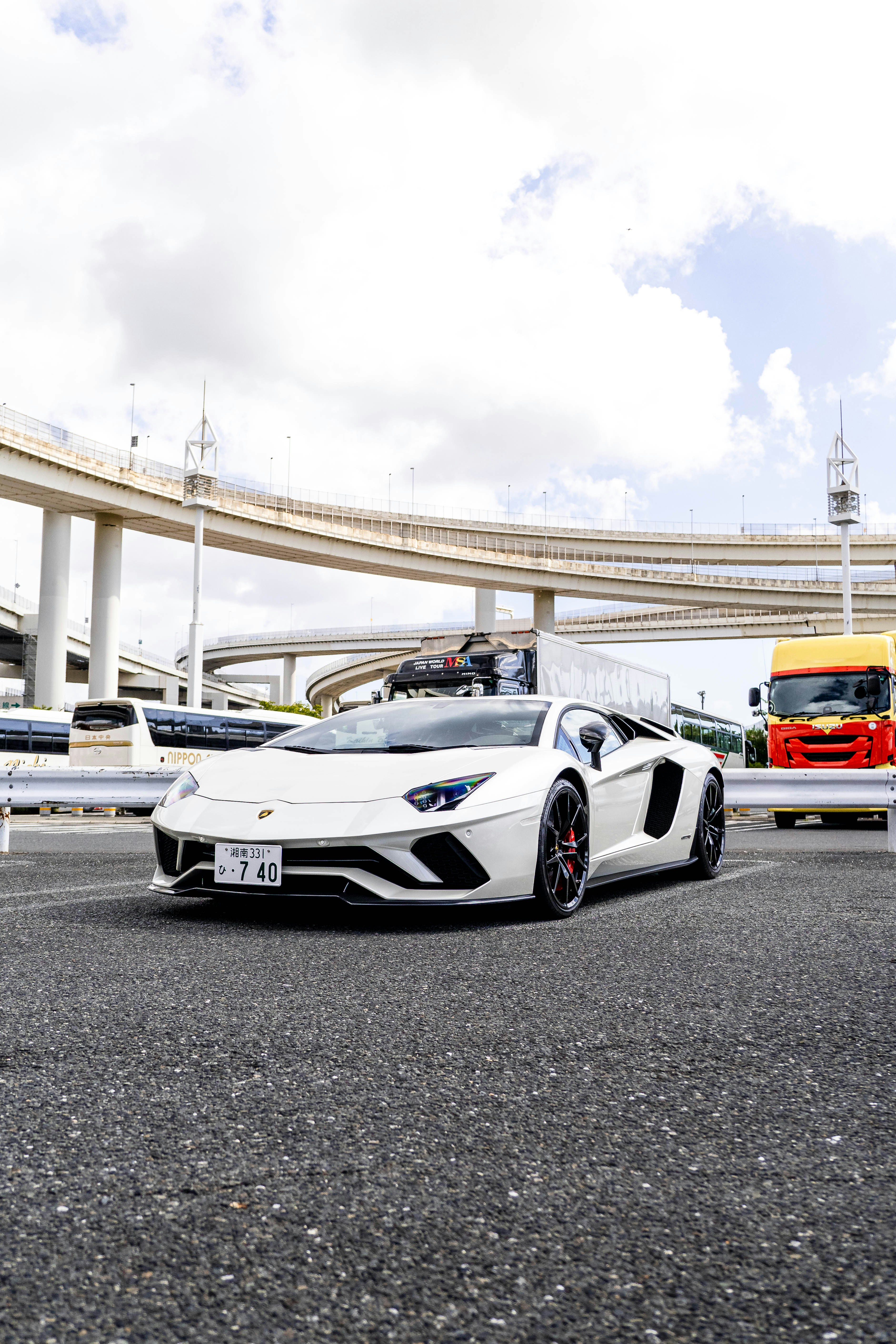 White Aventador at a Concrete Intersection