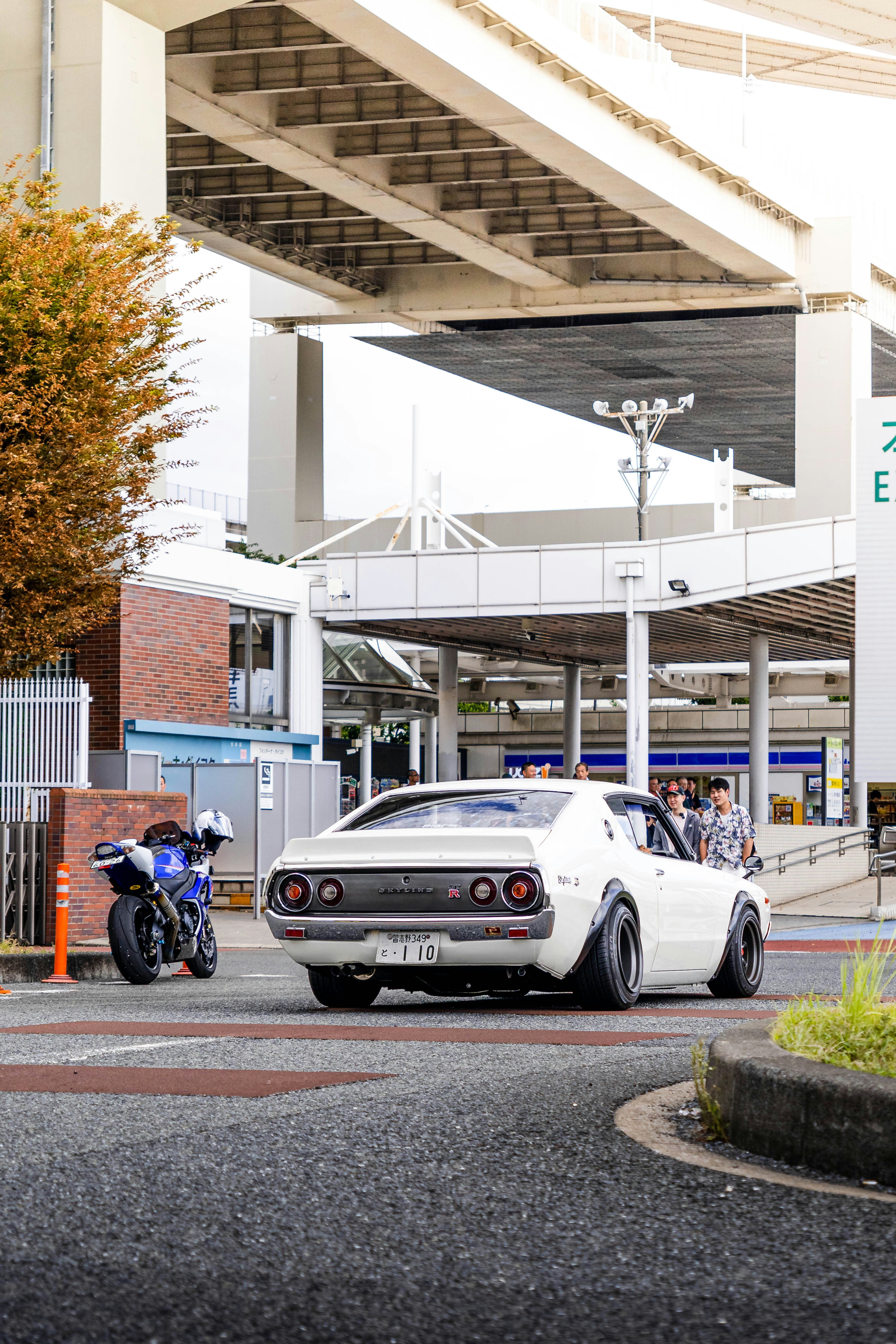 White Drift: A Classic Sedan Meets Modern Transit Hub