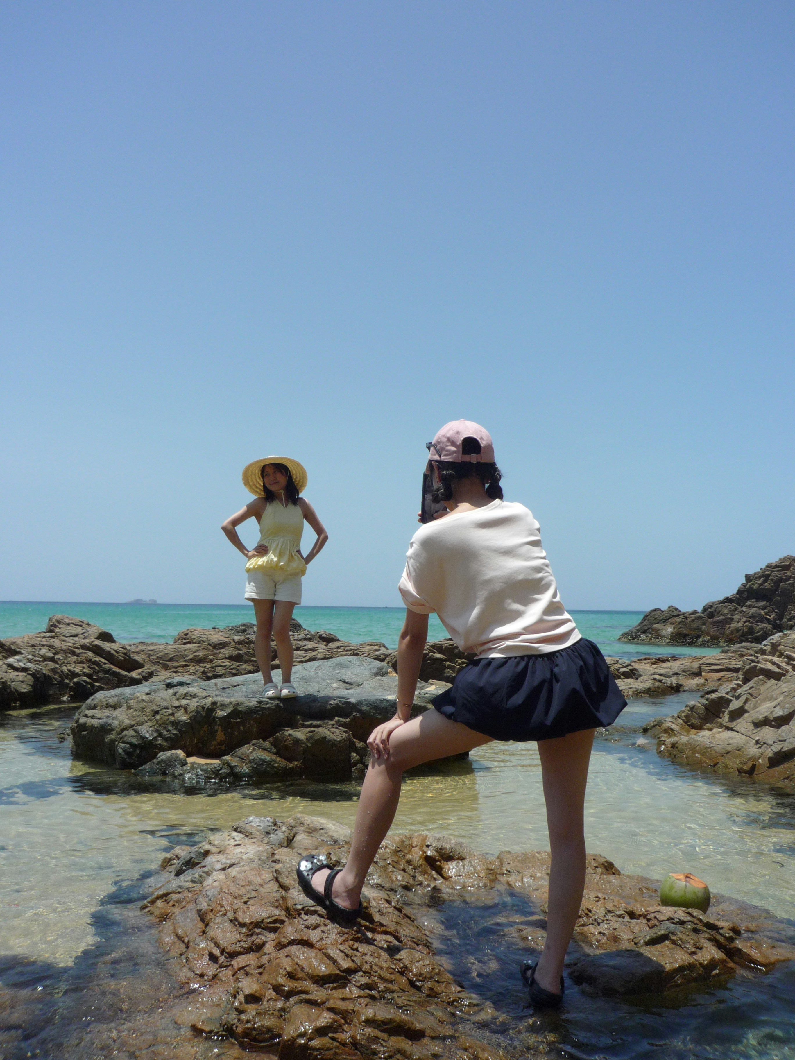Sunlit Beach Confrontation: A Quiet Portrait Between Rocks and Sea