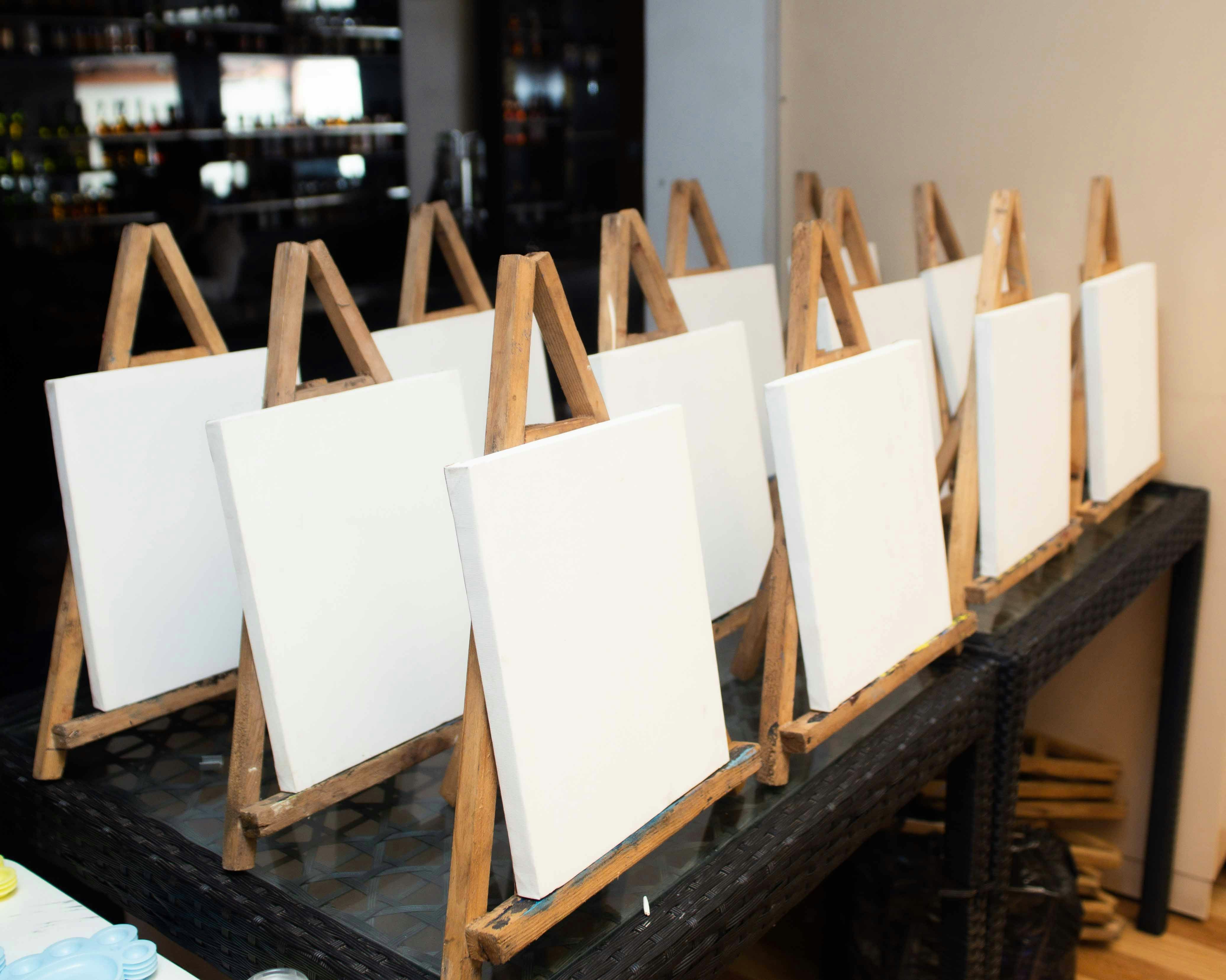 Row of Mini Easels, Blank Canvases, and a Subtle Barback Reflection