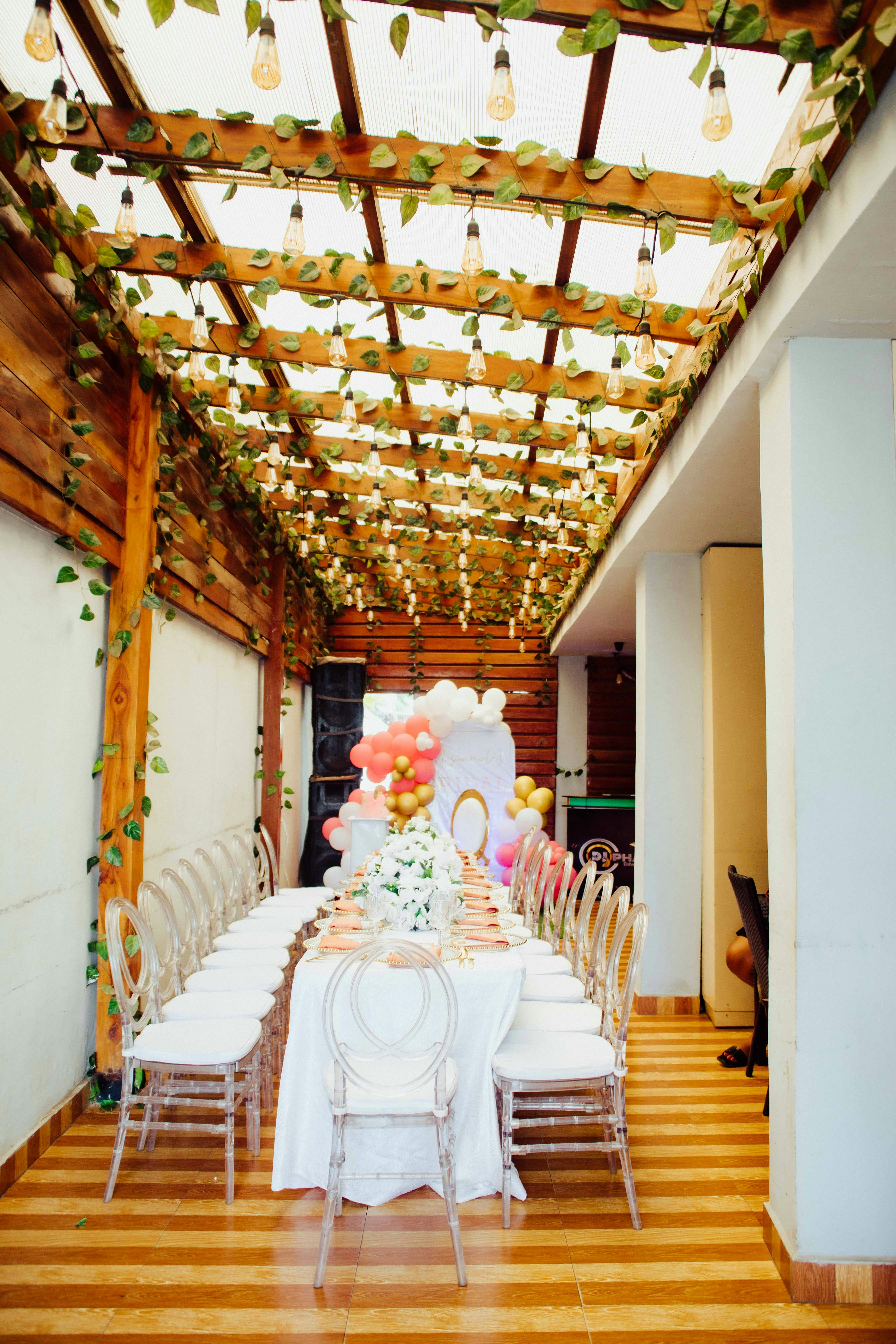 Festive Long Table Under Lantern-Decorated Trellis