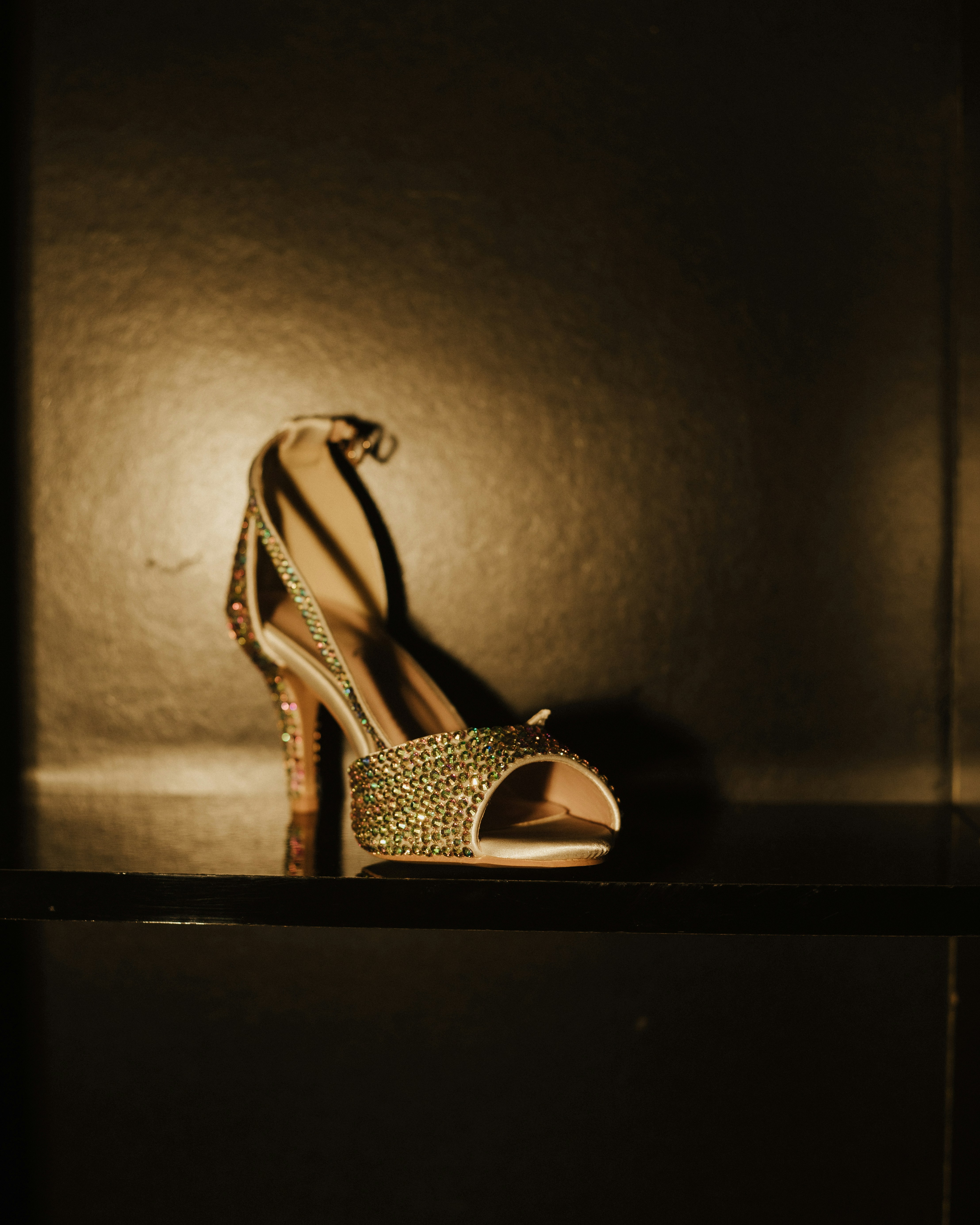 Gilded Step: A Solitary Stiletto in Subdued Spotlight