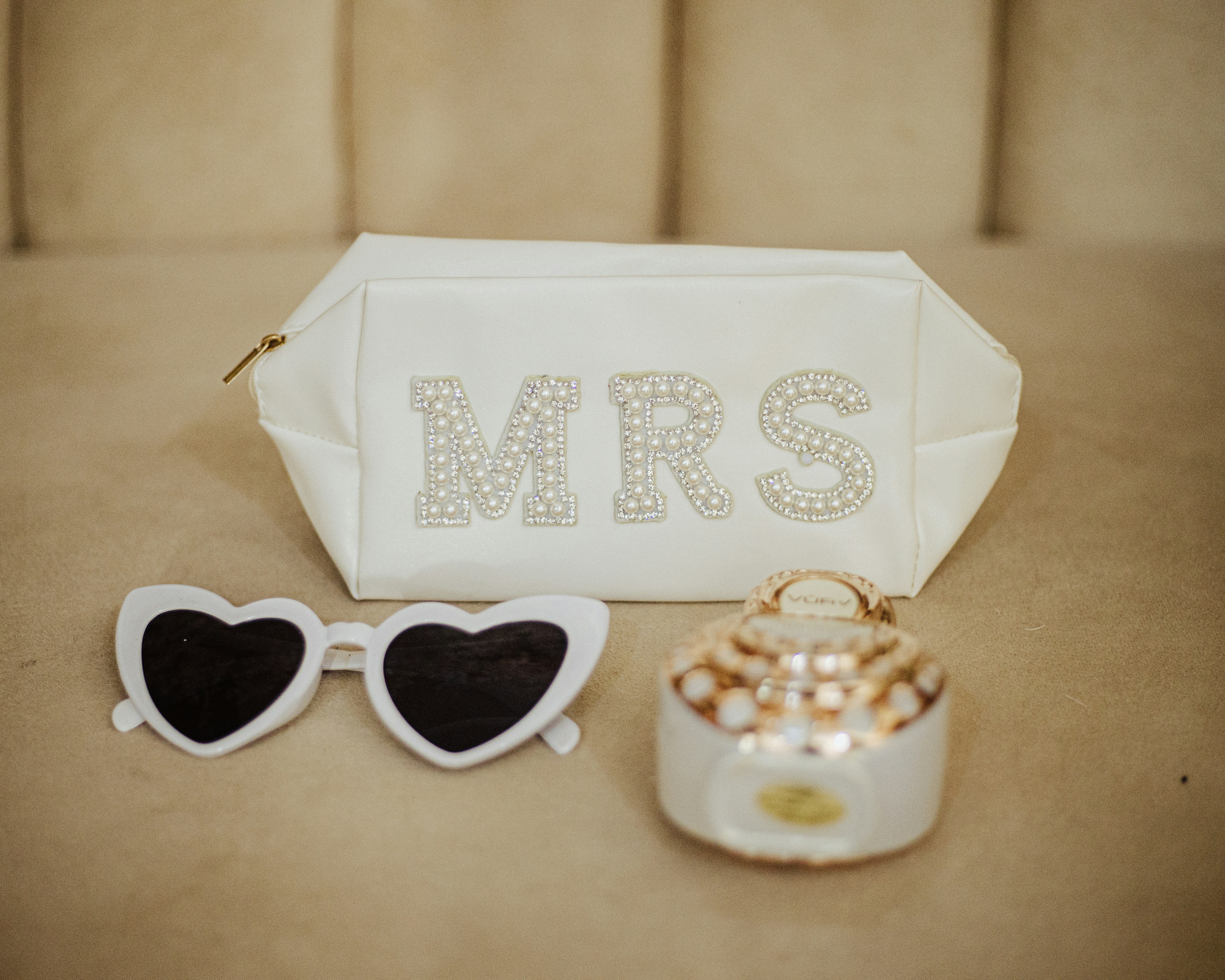Sparkling Simplicity: A White Pouch, White Glasses, and Rose-Gold Timepiece