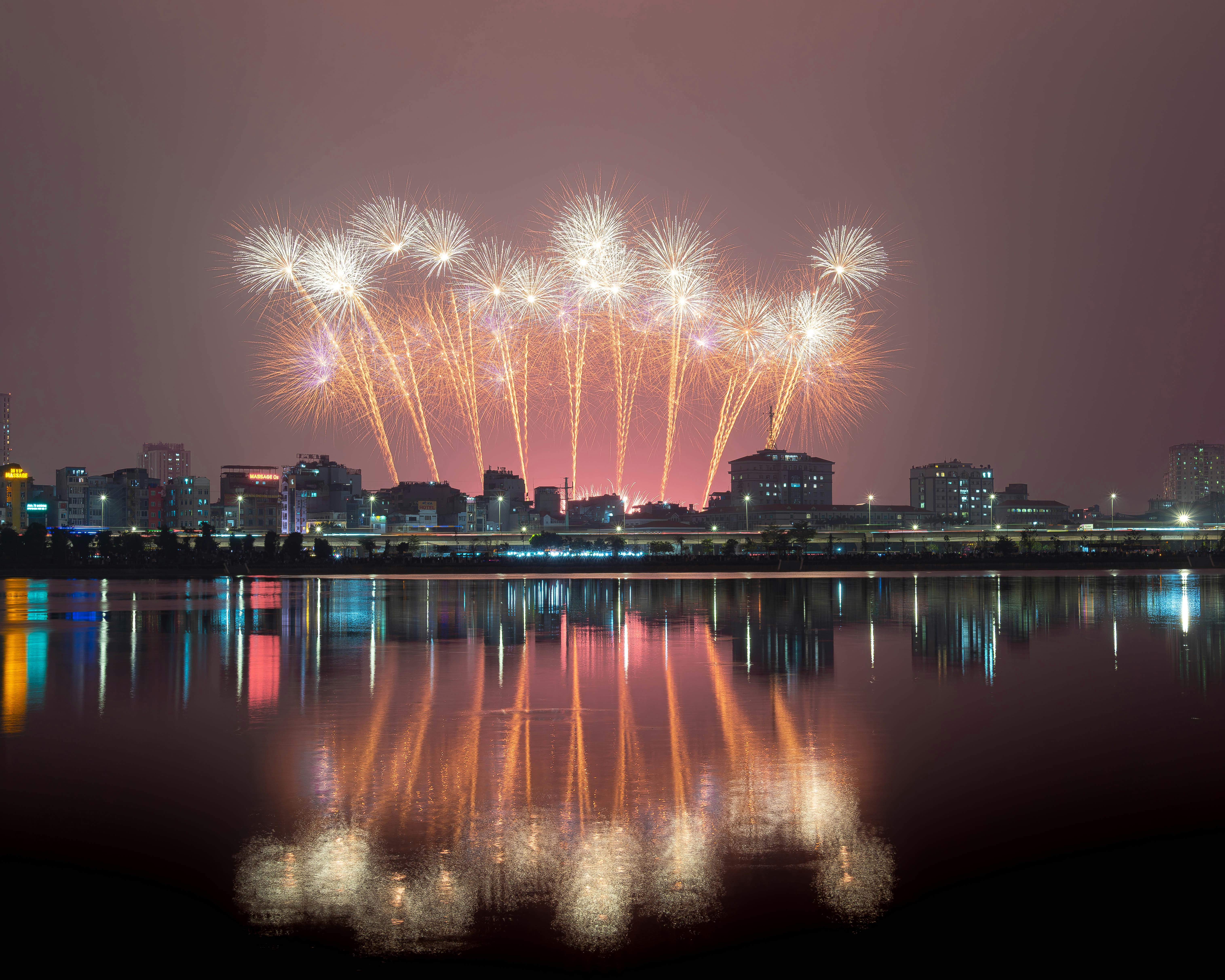 Night Skyward Echoes: Fireworks over a City Silhouette