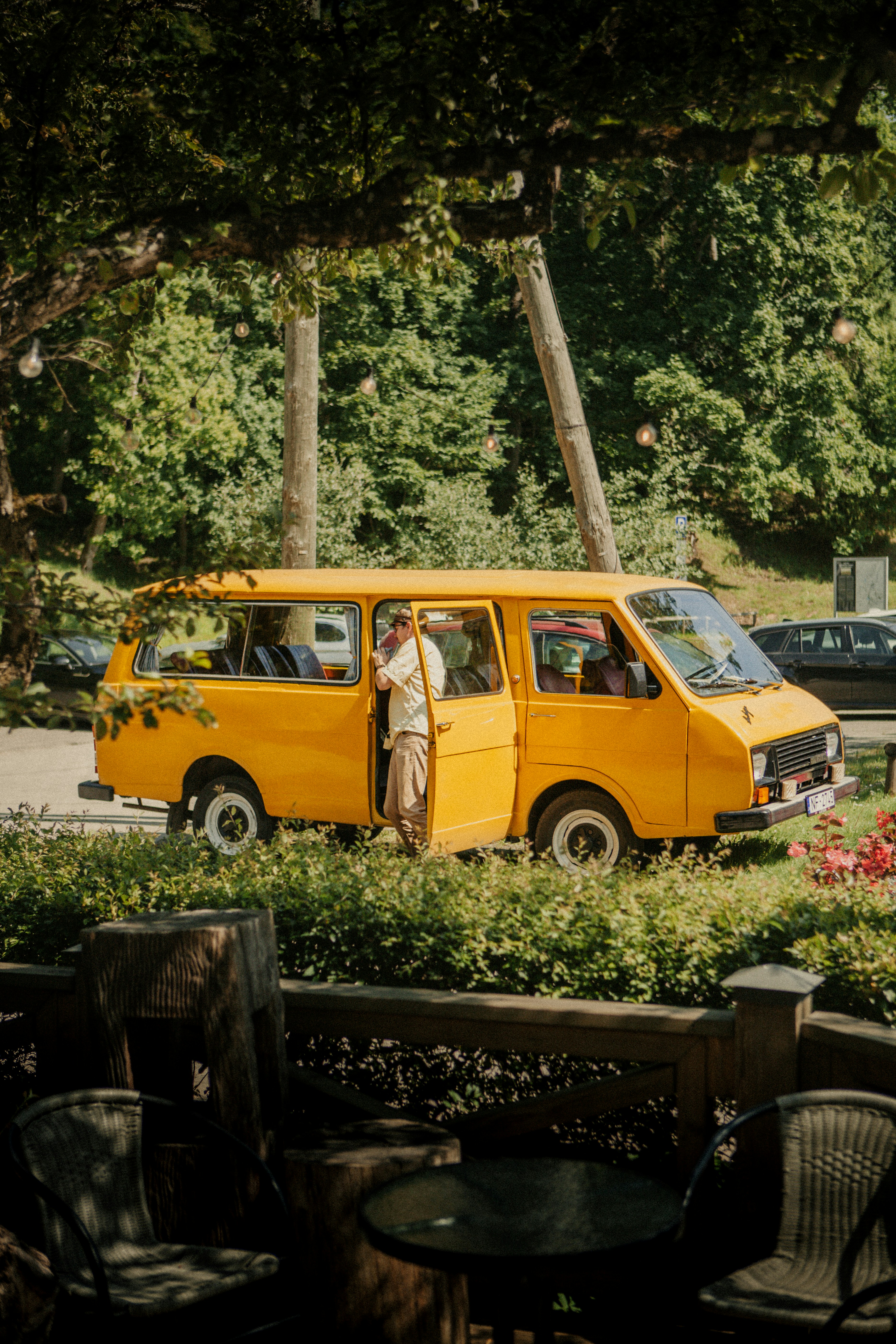 Yellow Van at the Park: A Quiet Moment by the Open Door