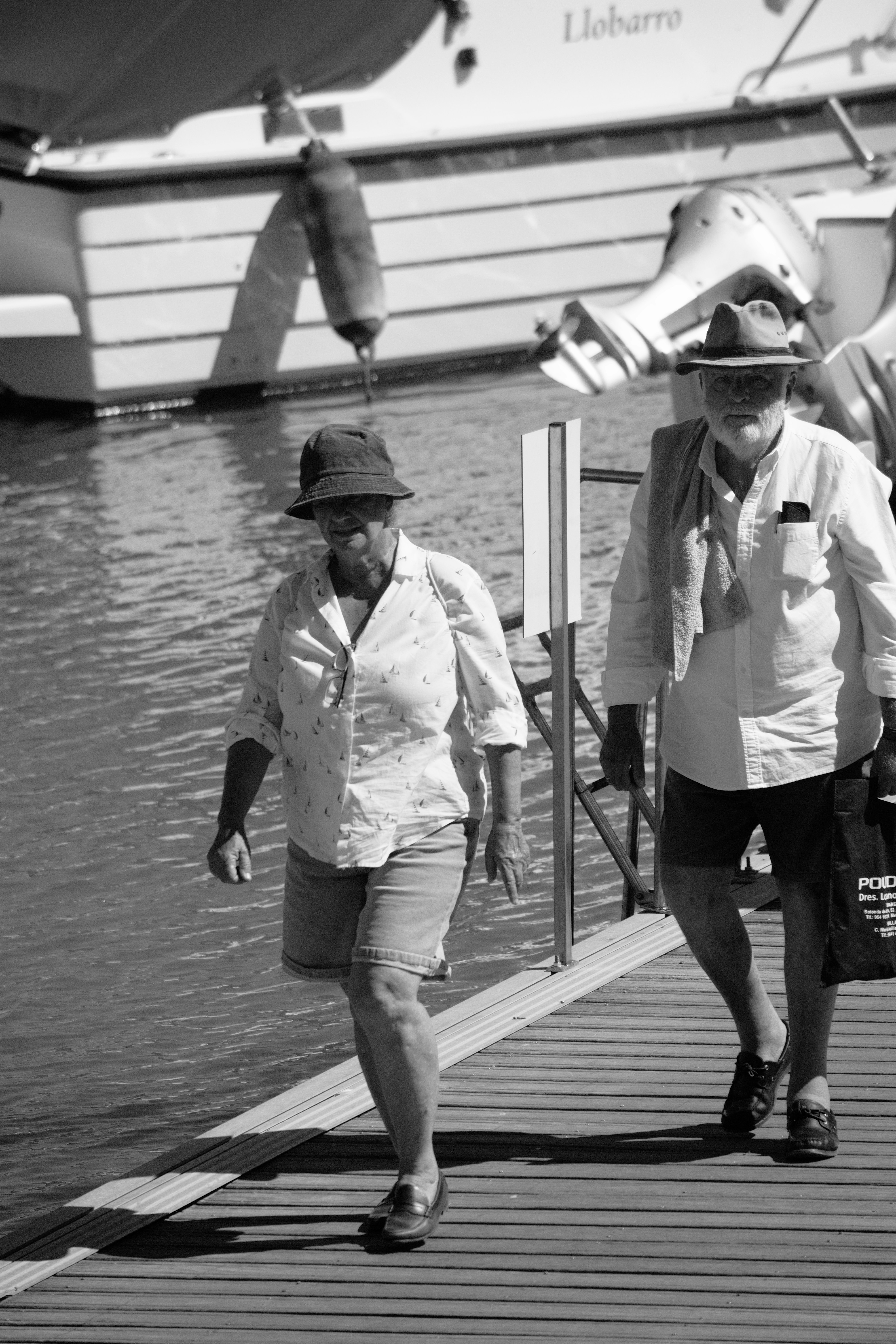 Evening Stroll: Dual Gentlemen Walking the Wooden Pier