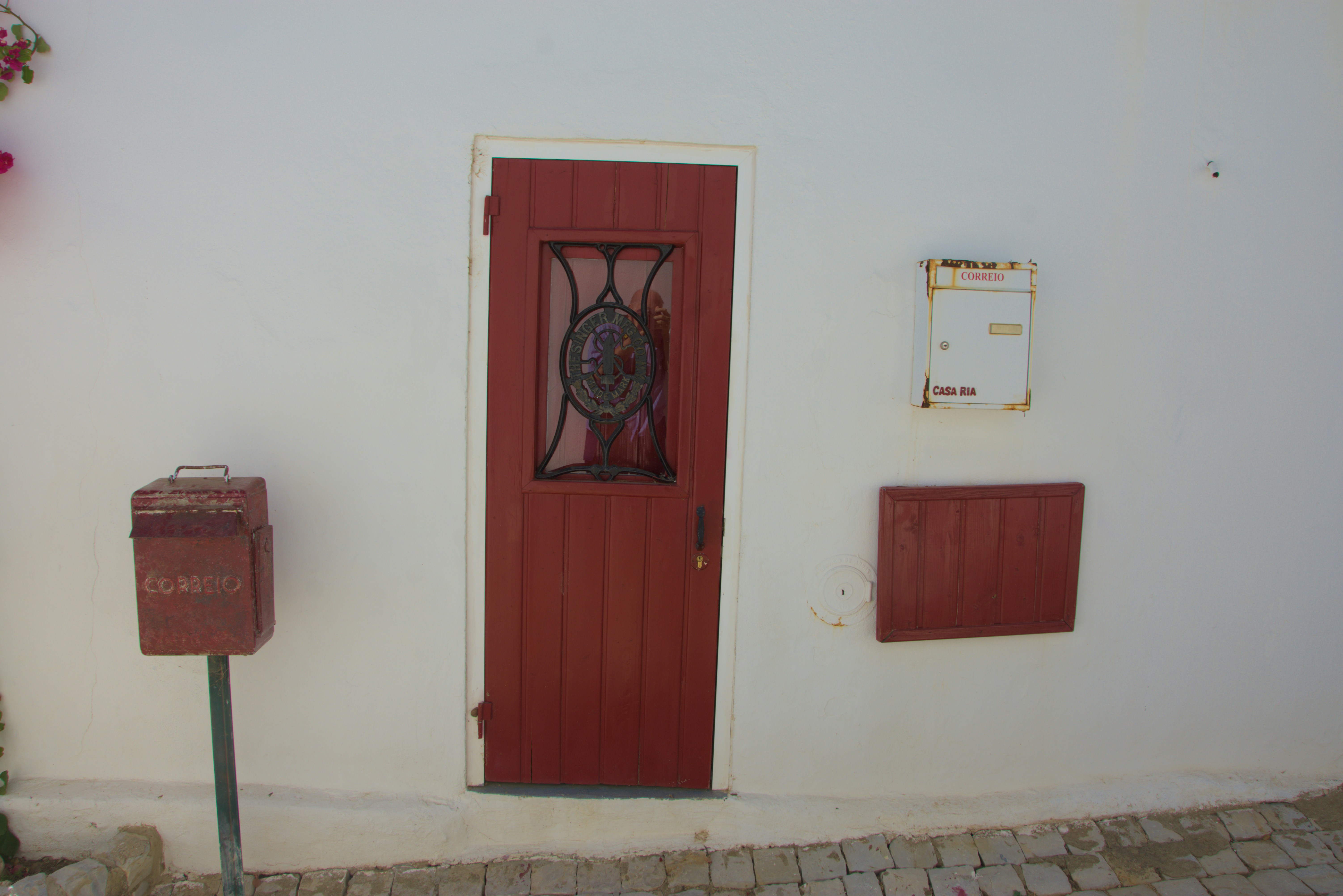 Red Door at White Facade: A Quiet Street Scene