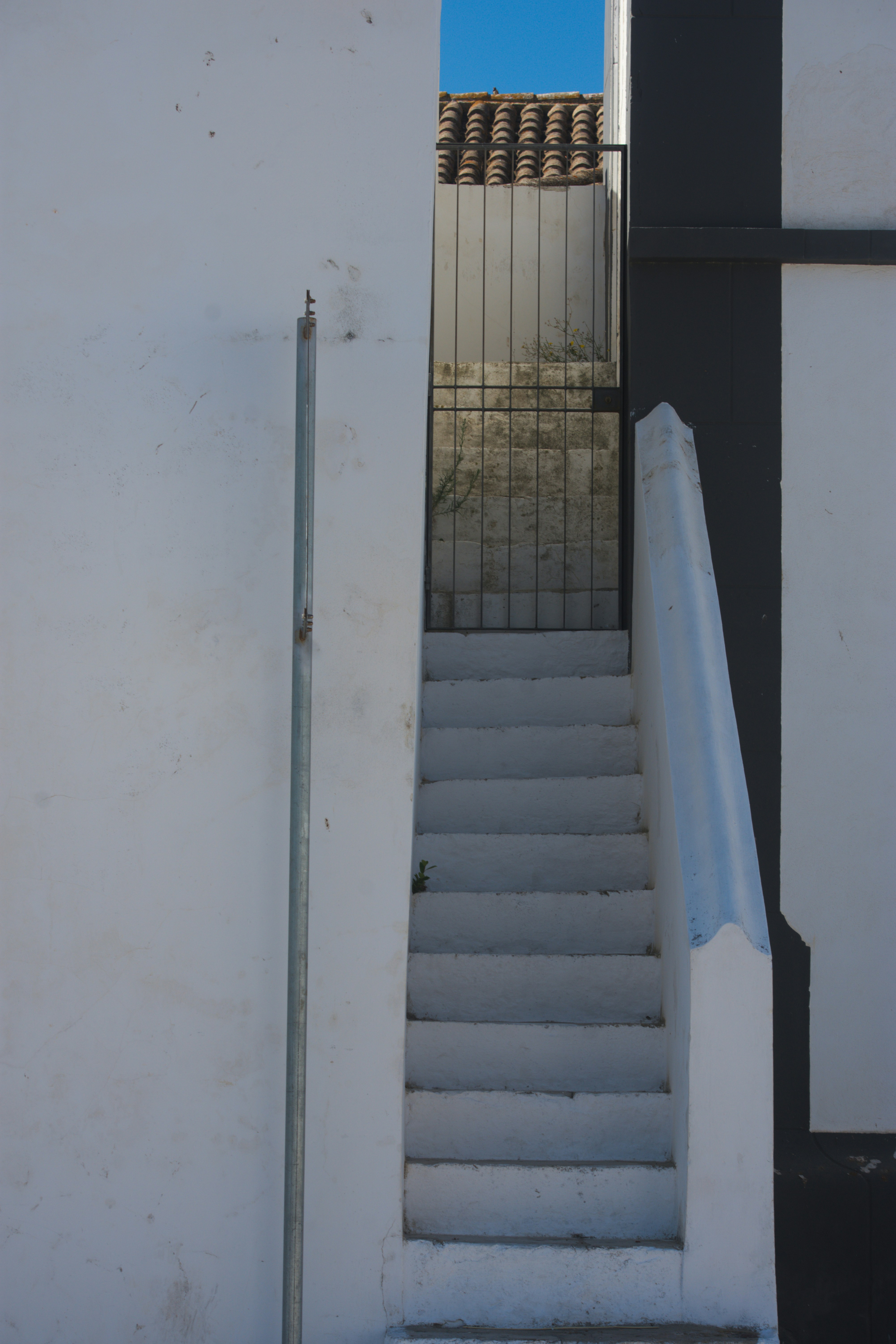 White Staircase to a Gate: A Narrow Corridor of Light