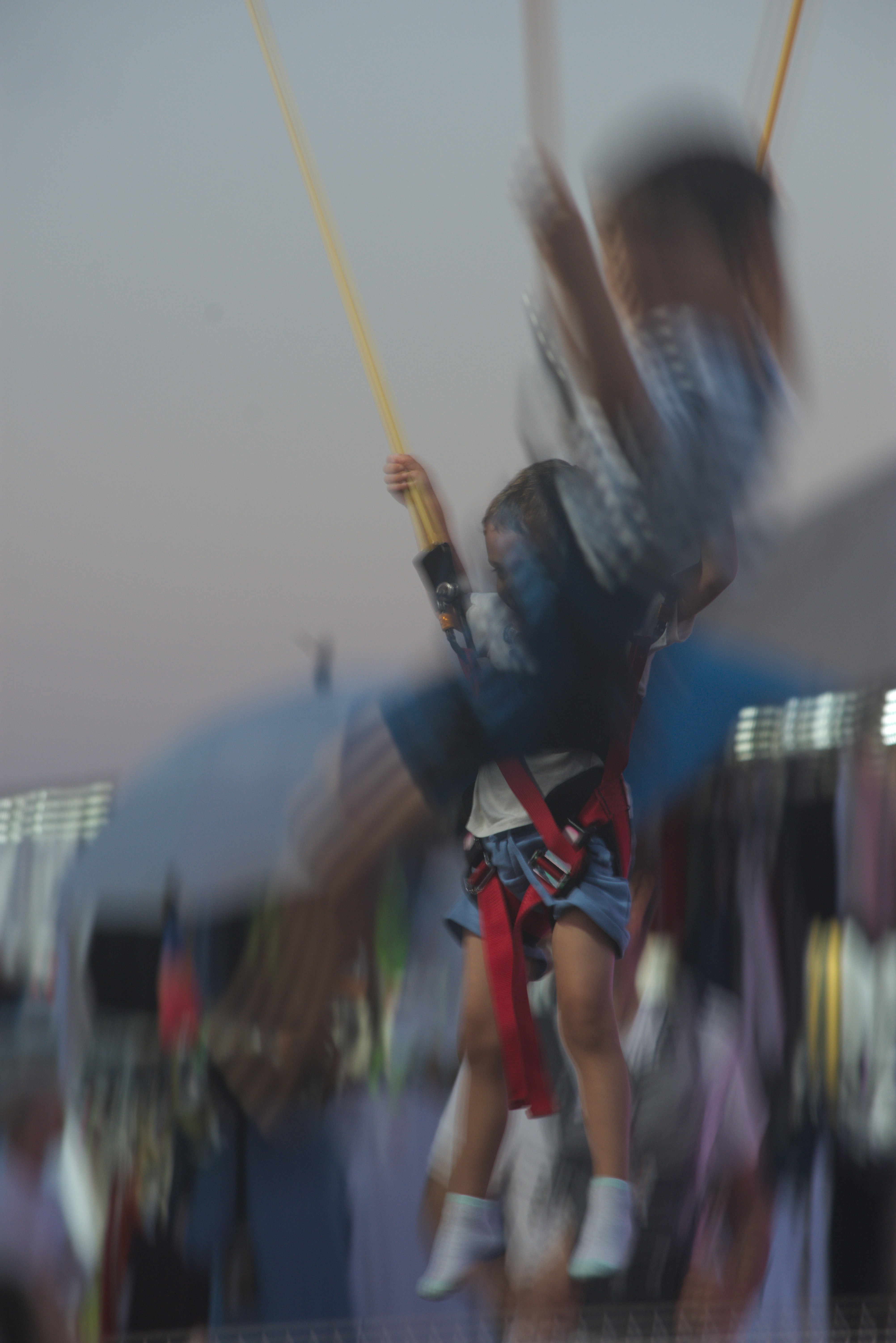 Swinging Through Blur: A Moment on the Carnival Ride