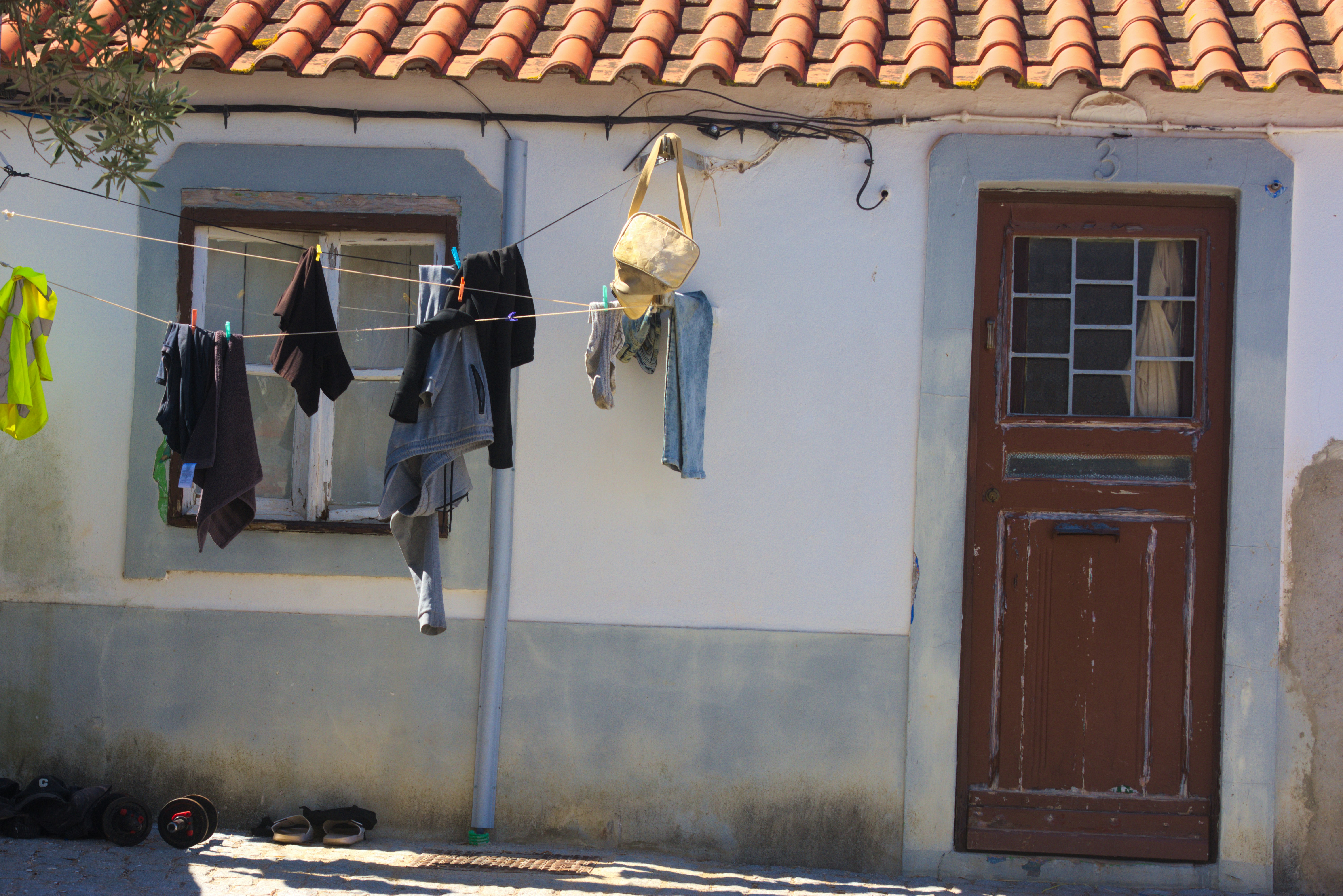 Washing Line Portrait: A Quiet Moment on a Sunlit Street