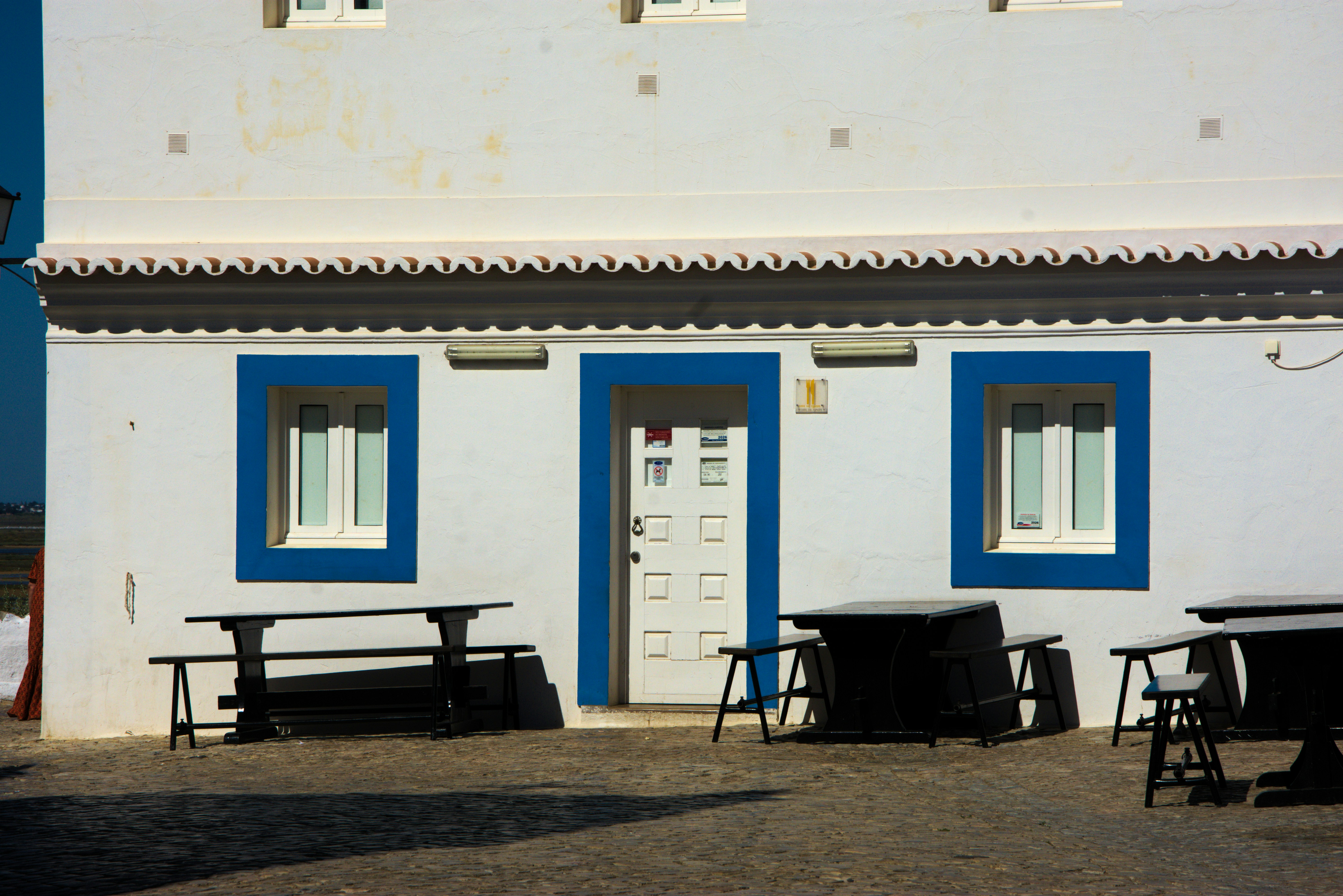 White-washed Café Facade with Bold Blue Accents