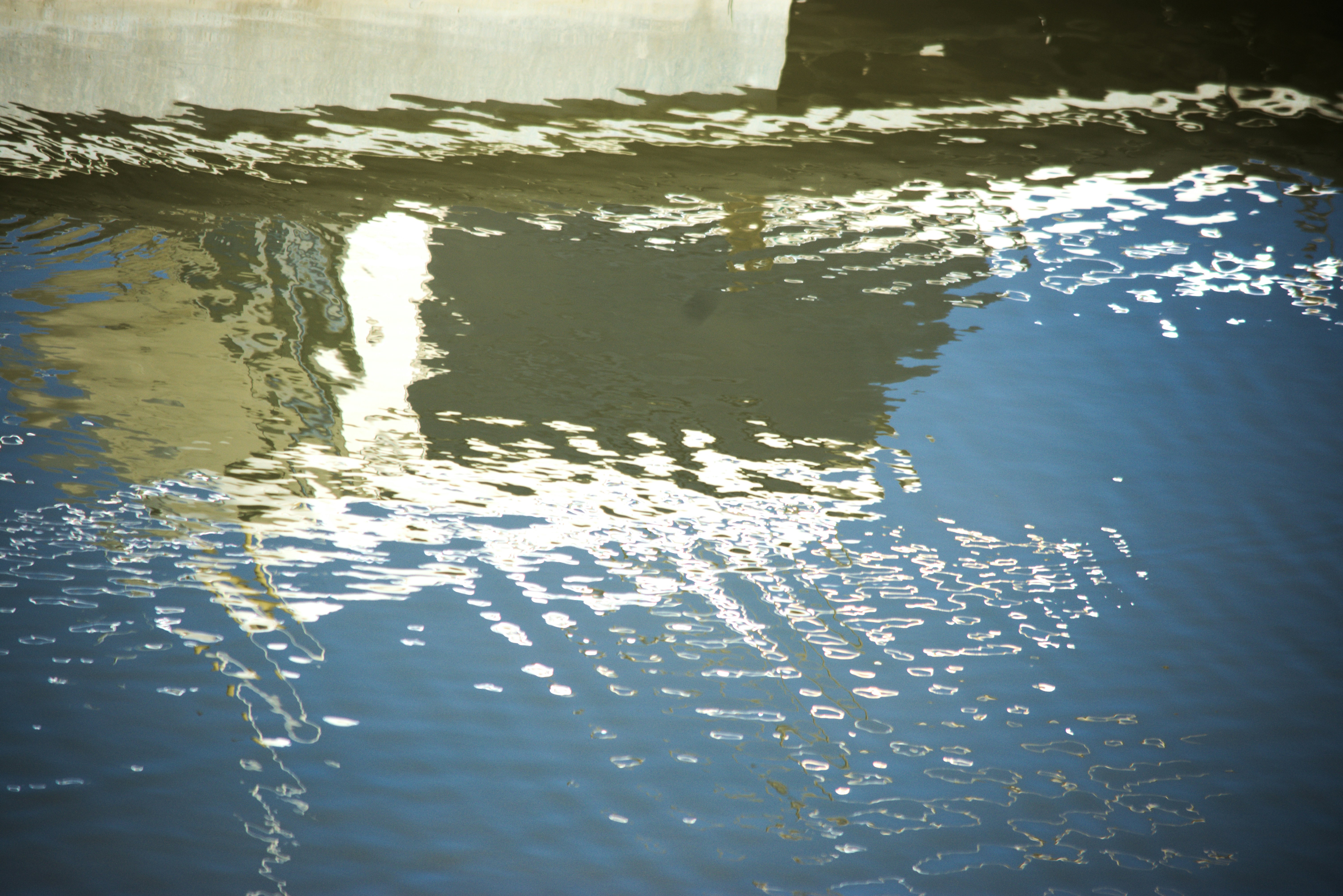 Ripple Portrait: Sky, Concrete, and Water in a Quiet Reflection