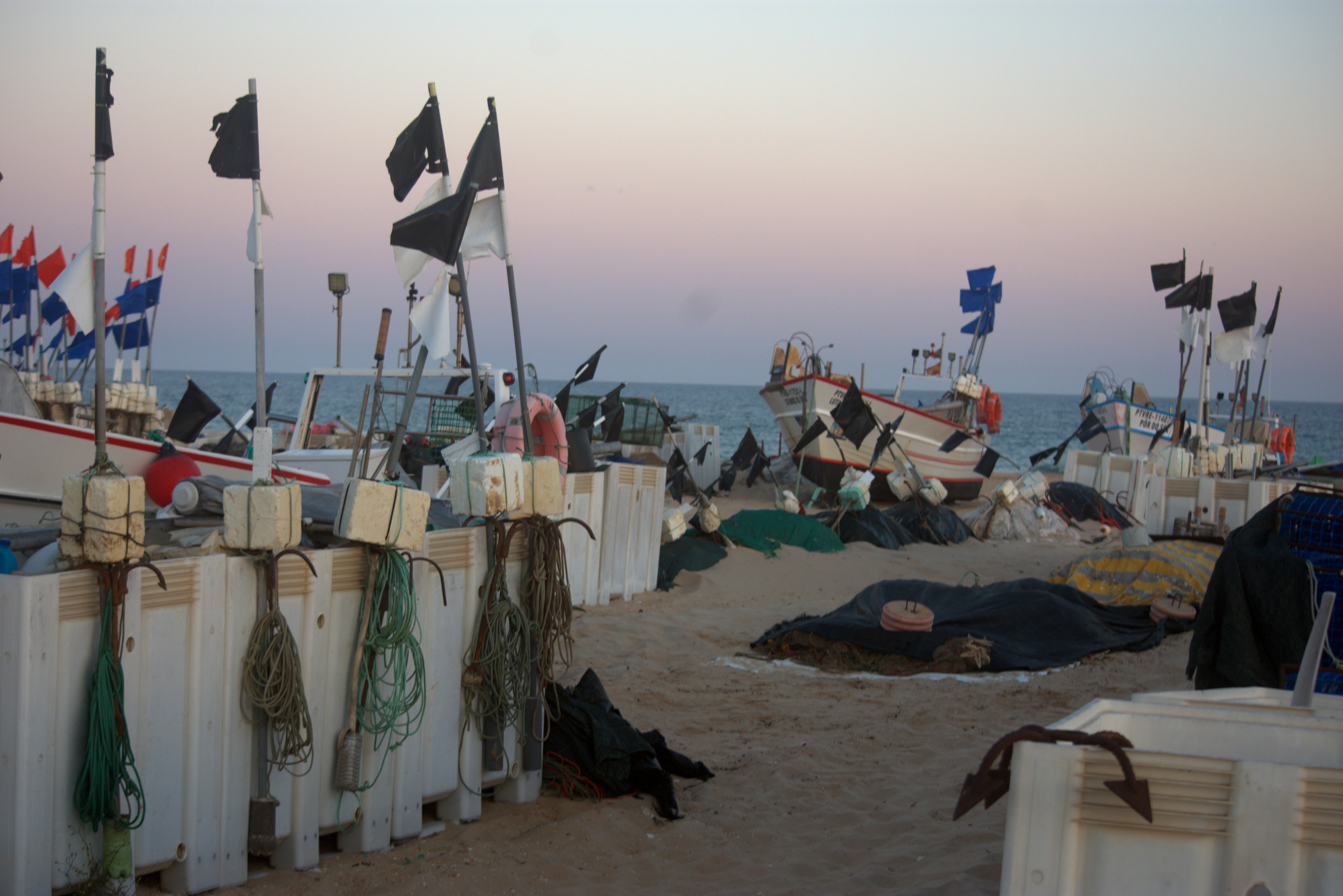 Flagged Boats and Nets at Dusk on a Seaside Pier