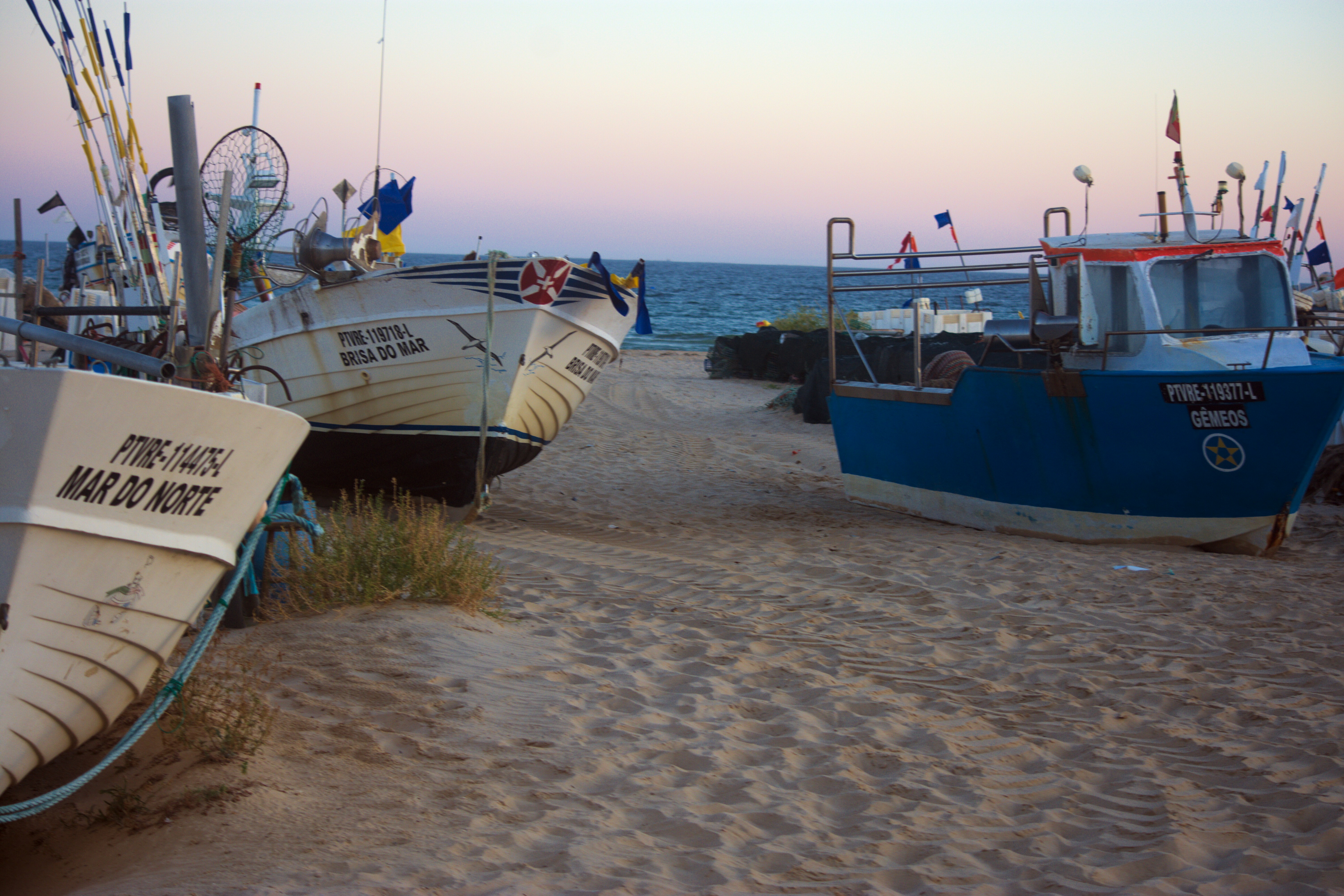Harbor Calm: Boats Rest on Sandy Path at Dusk