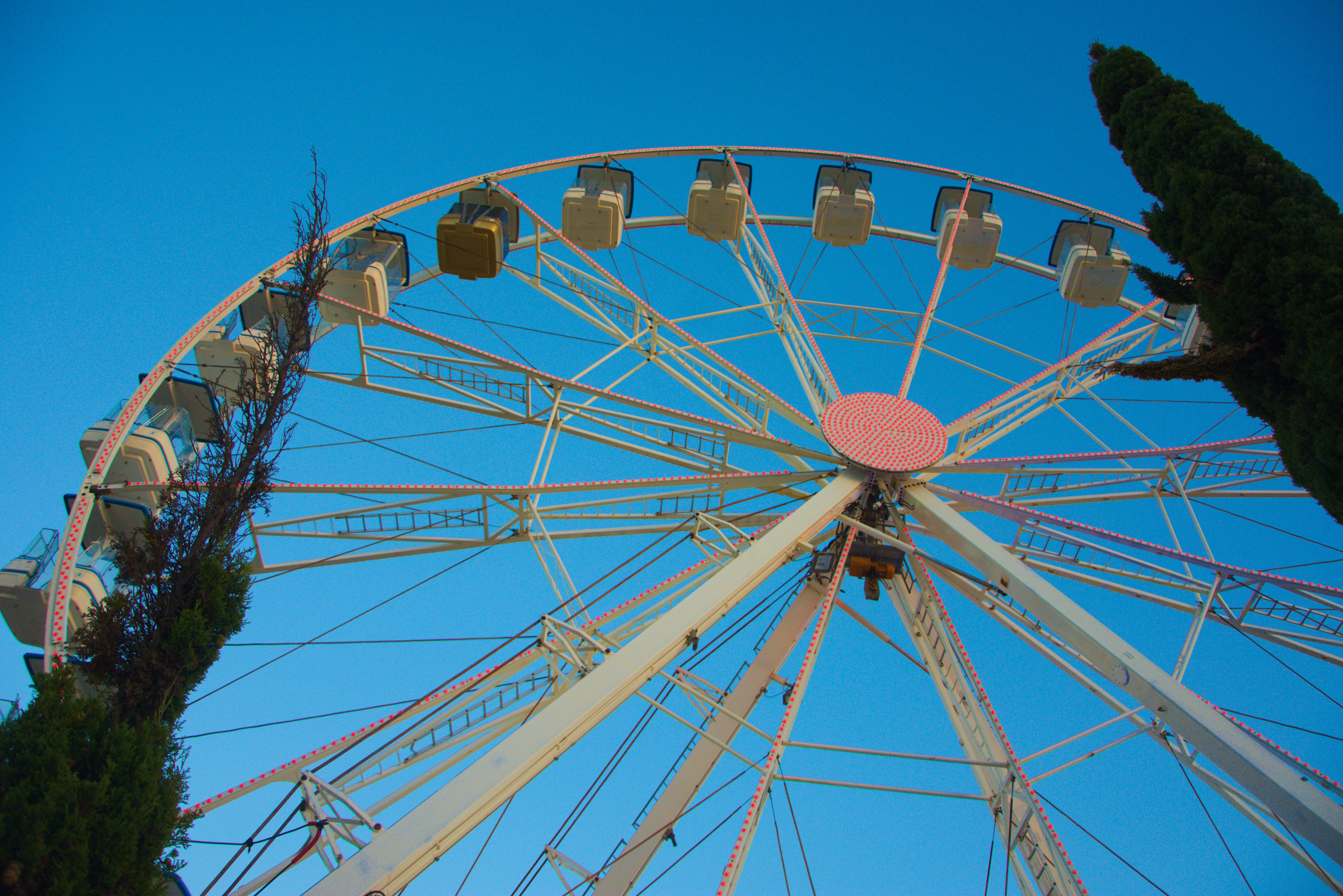 Blue Skies and a Spoked Giant: A Ferris Wheel Reaching Toward Summer