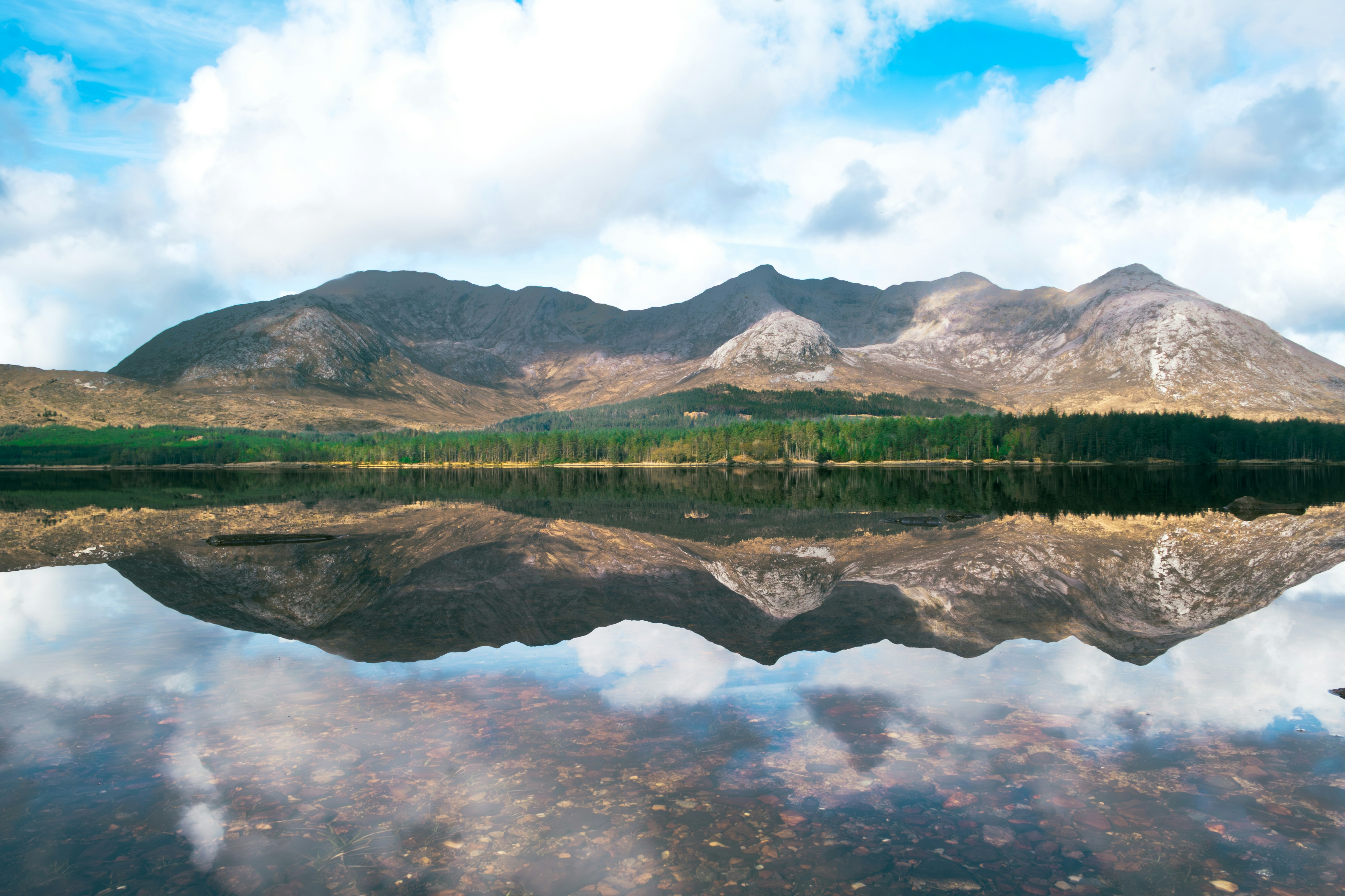 Echoes on Glass: Mountain skyline mirrored in still waters