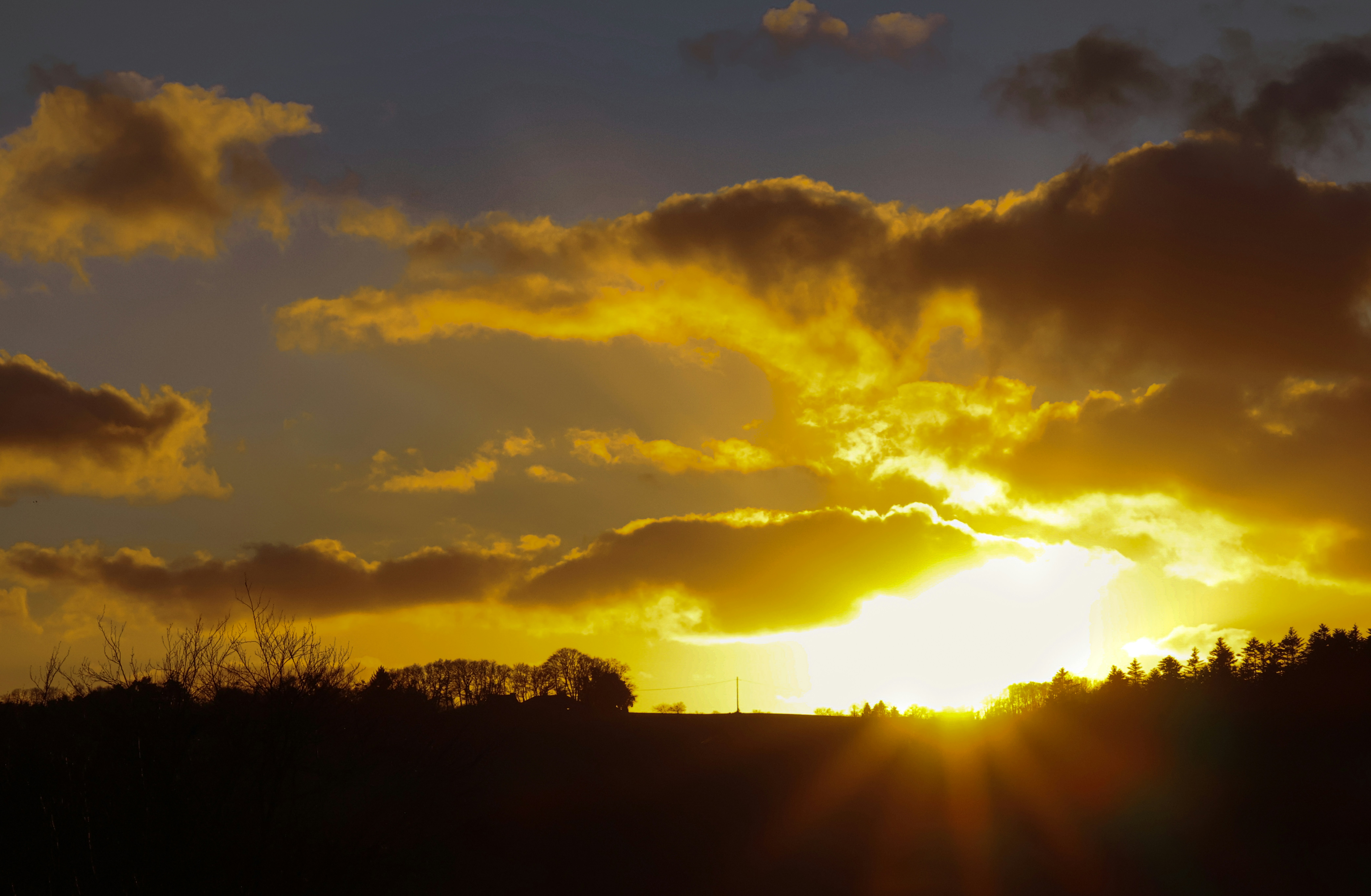 Emergent Sunburst Over a Silhouetted Horizon