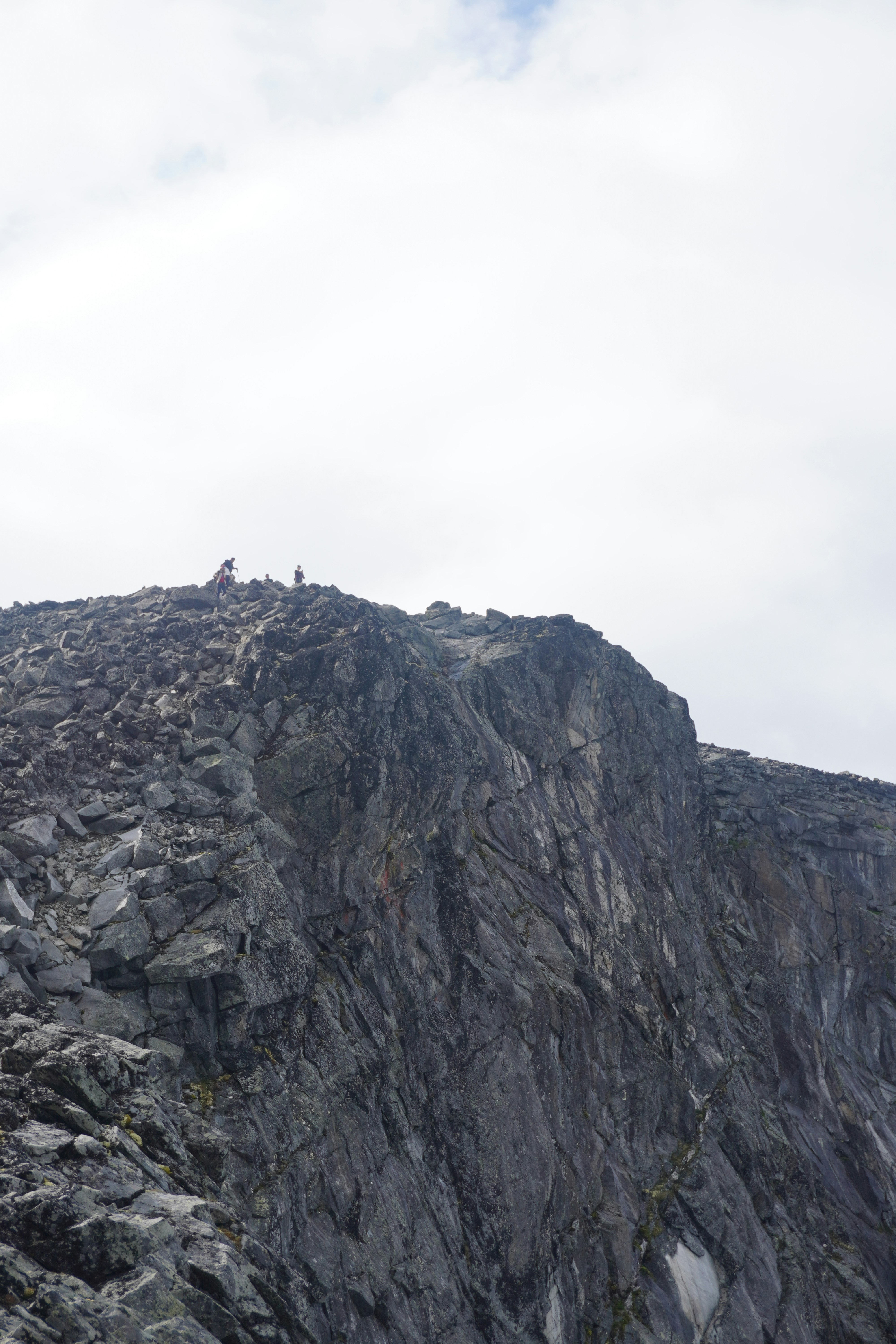 Rugged Summit: Climbers on the Edge of a Jagged Crest