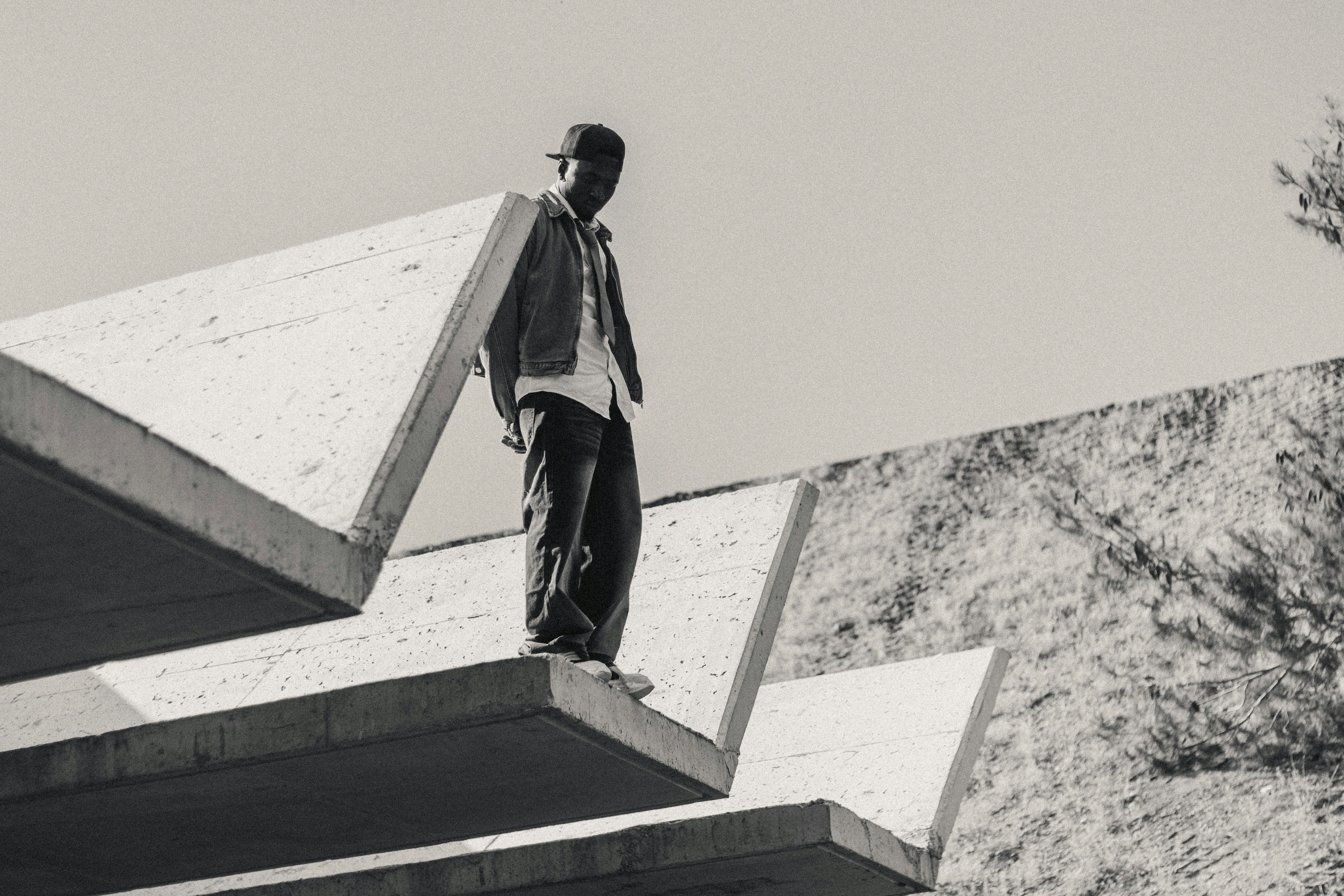 Man on the stepped concrete ramps: a quiet ascent above the hillside