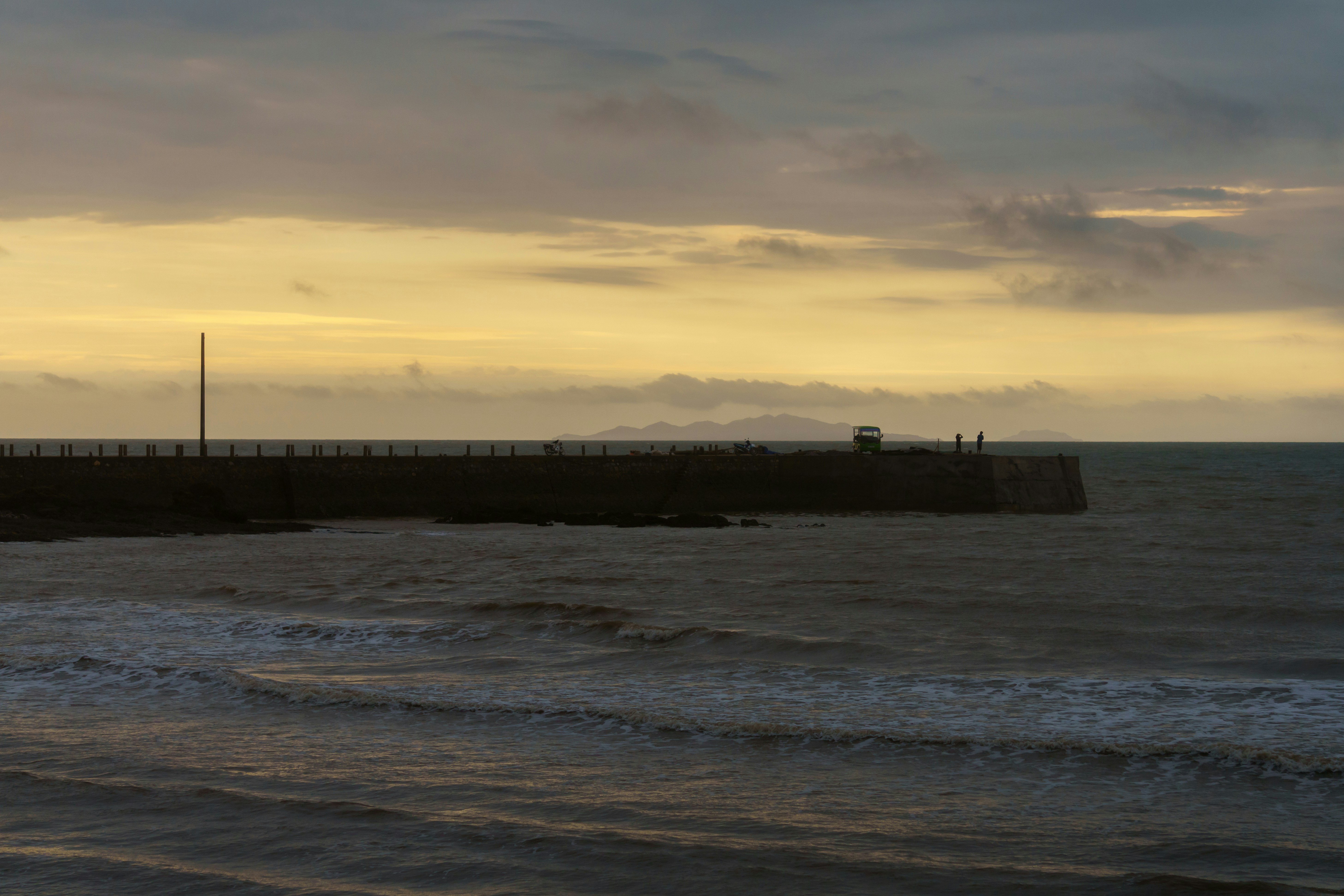 Sunset at the Pier: Quiet Horizon Over a Calm Sea