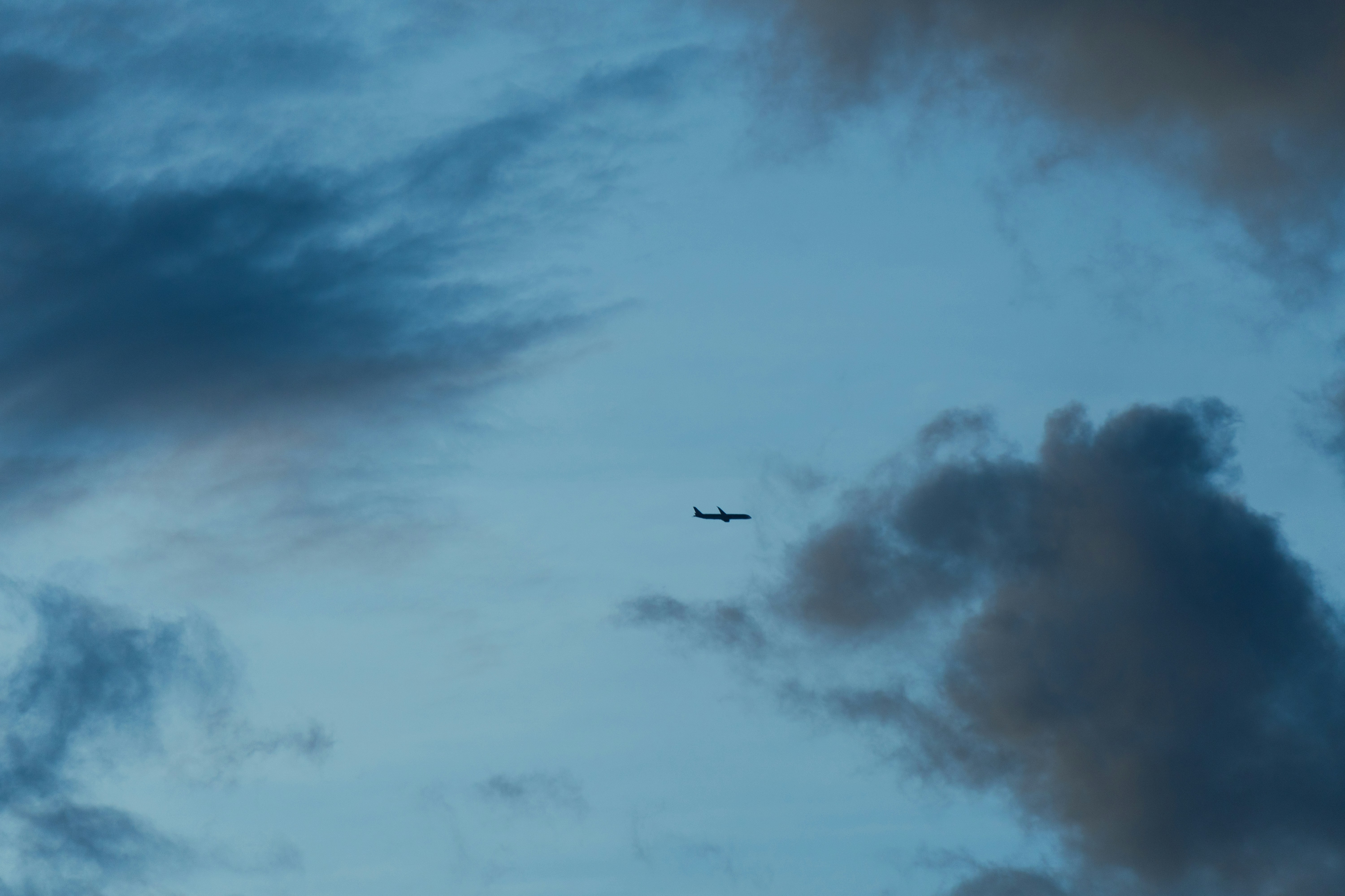 High-Altitude Speck: A Solo Plane in a Quiet Sky