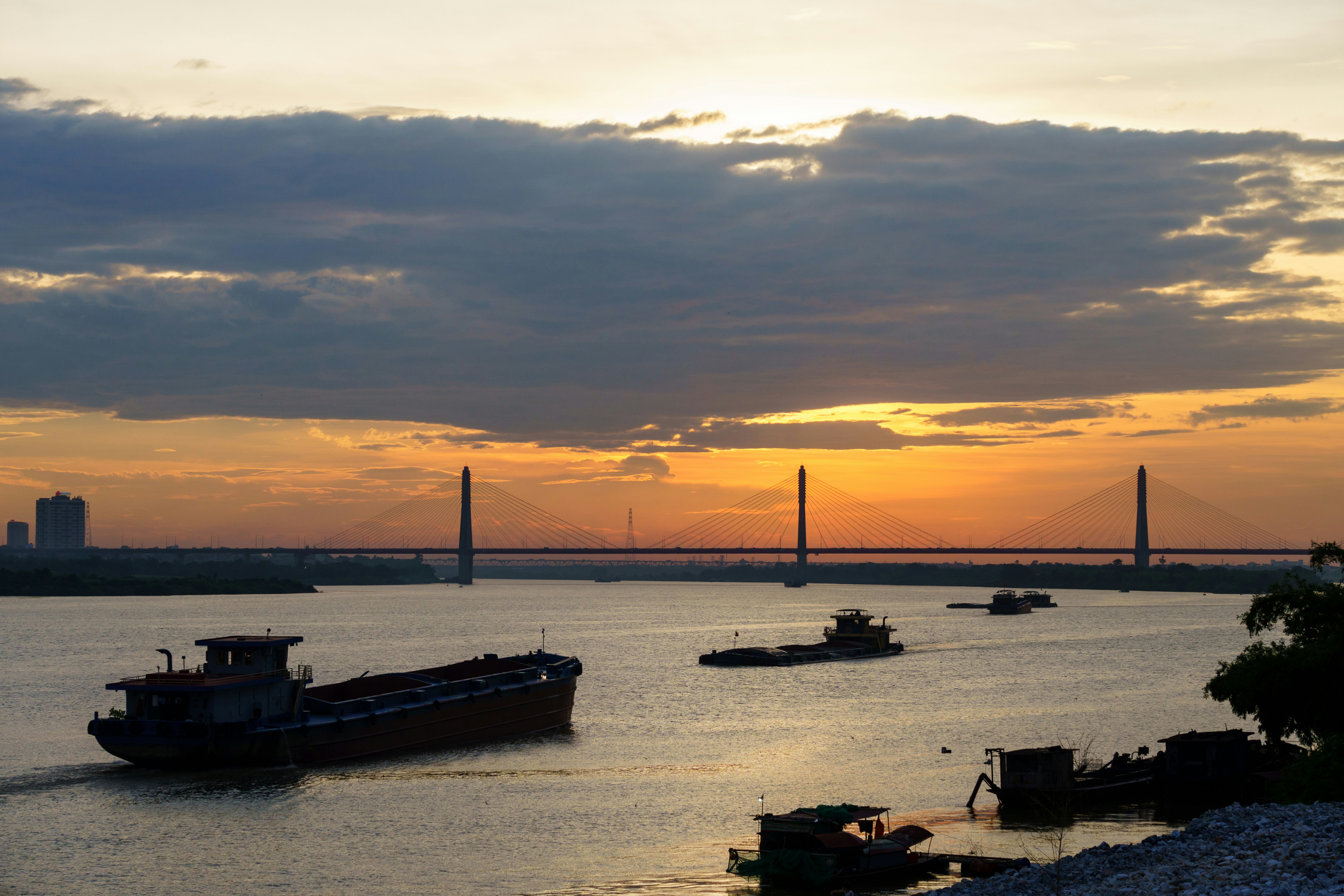 Sunset Run: Boats Silhouetted Against a Golden River