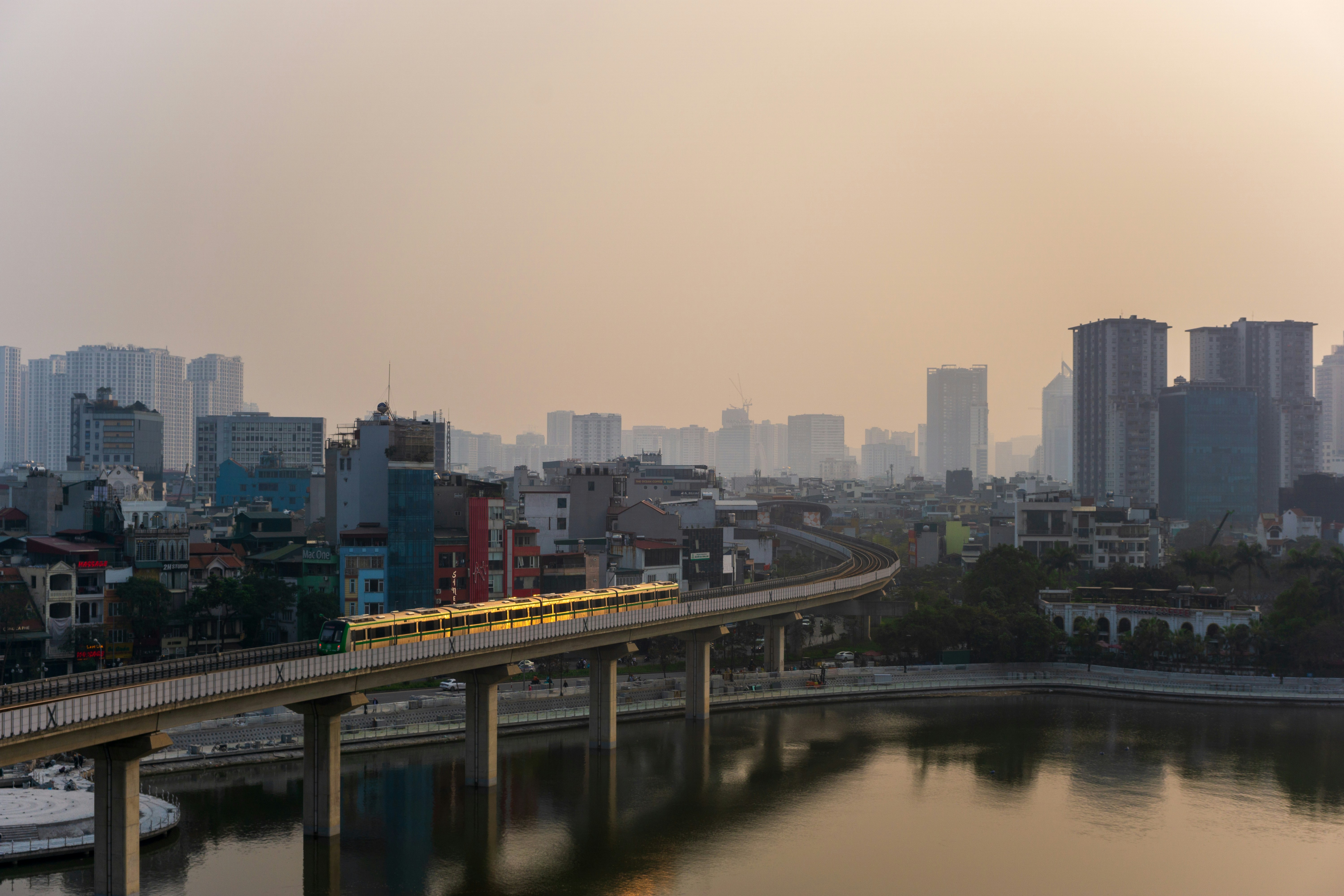 Sunset Train over the Quiet City: A Riverward Ascent