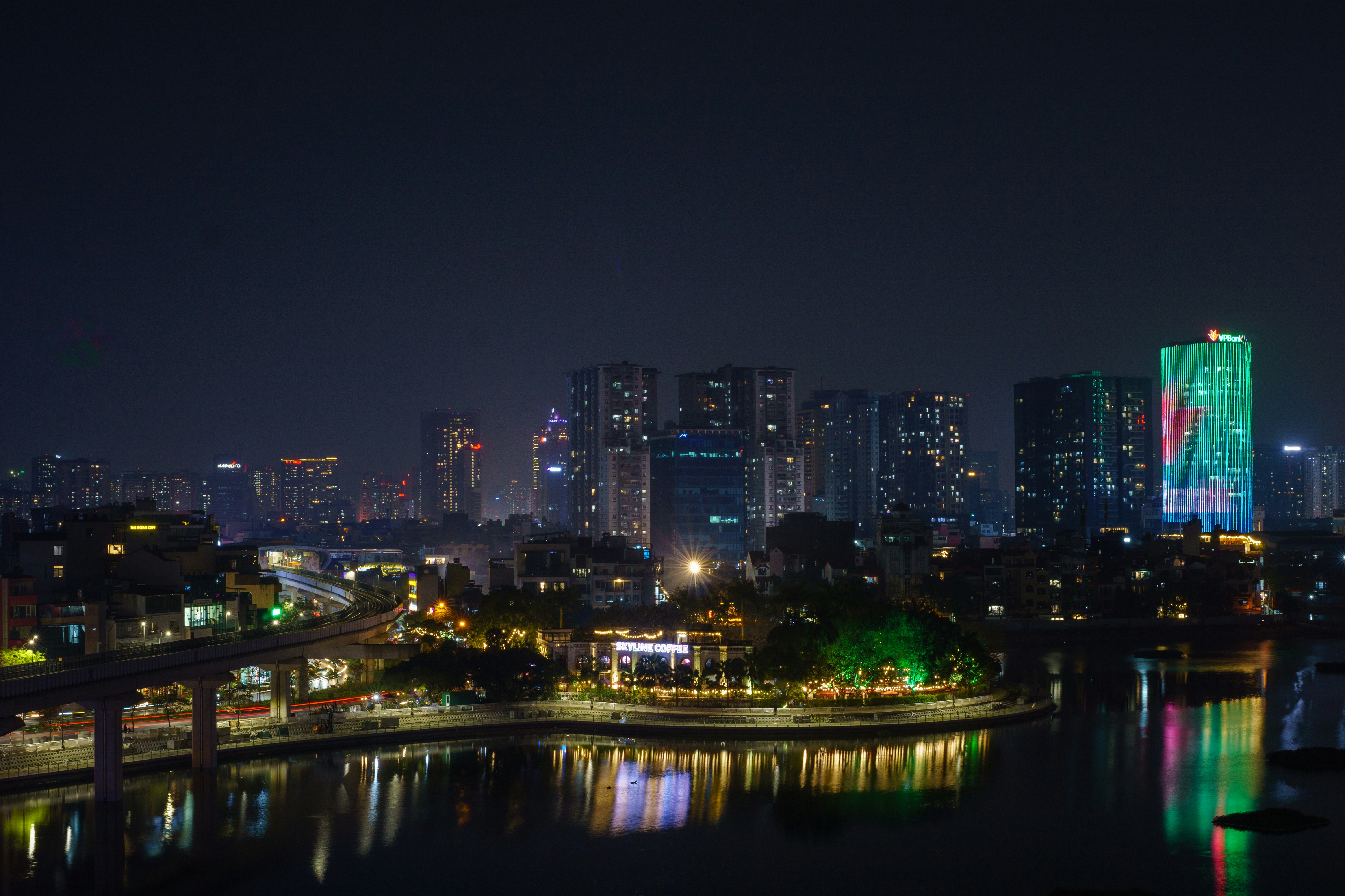 Neon Reflections Over the River: A Nightscape of City Light