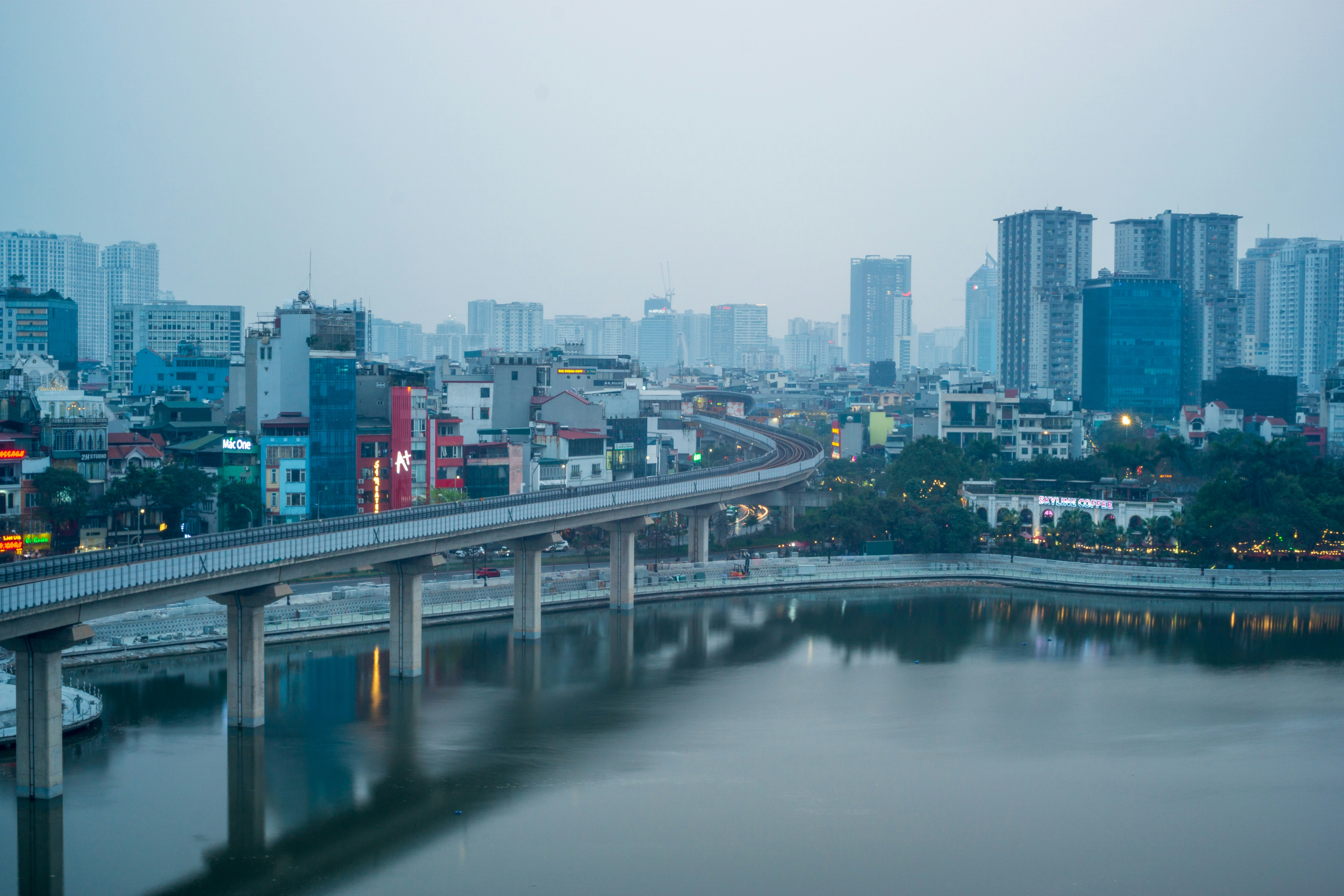 Bridge Over a Quiet River: Urban Skyline at Dusk
