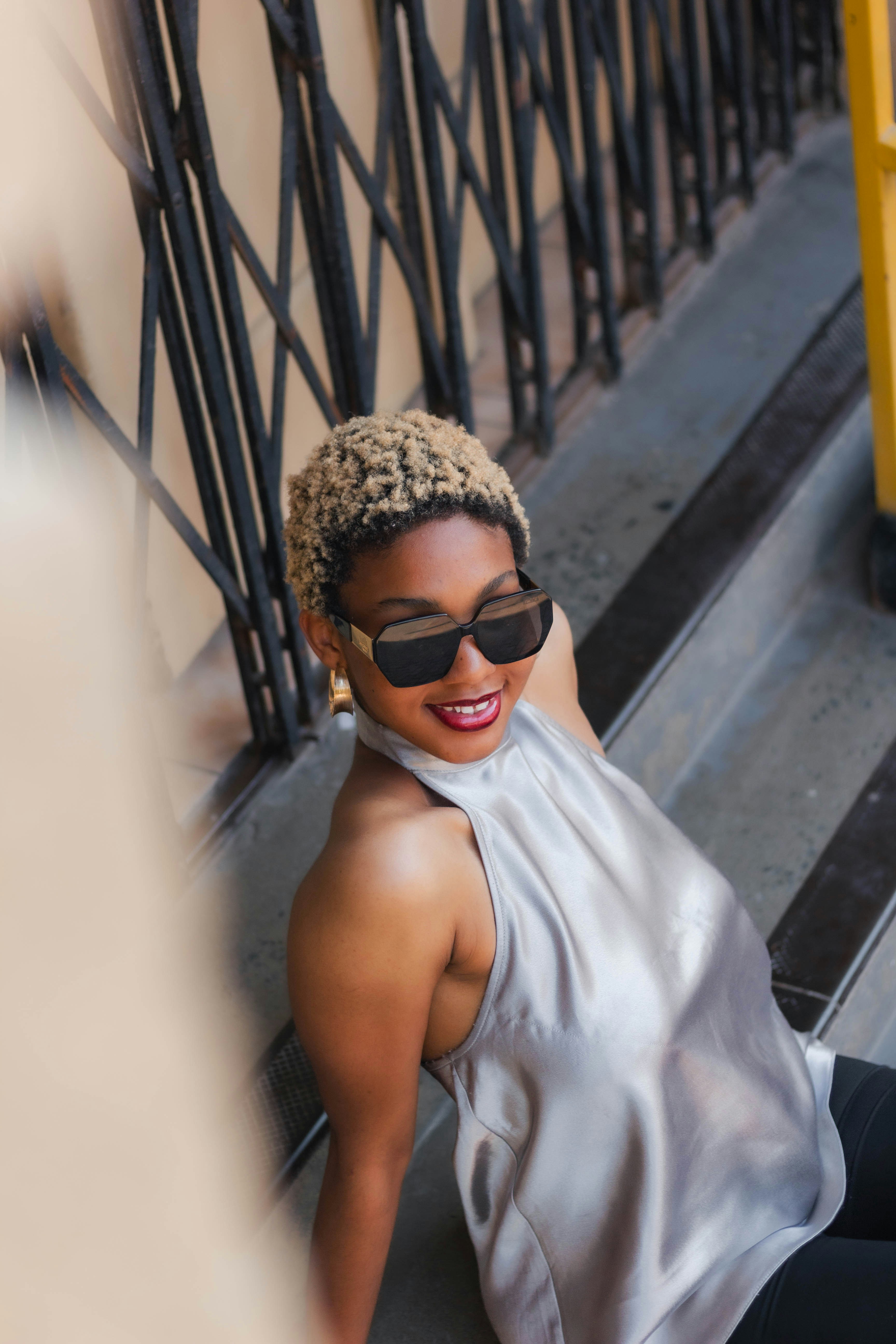 Urban Glimmer: Bold Portrait on Metal Steps