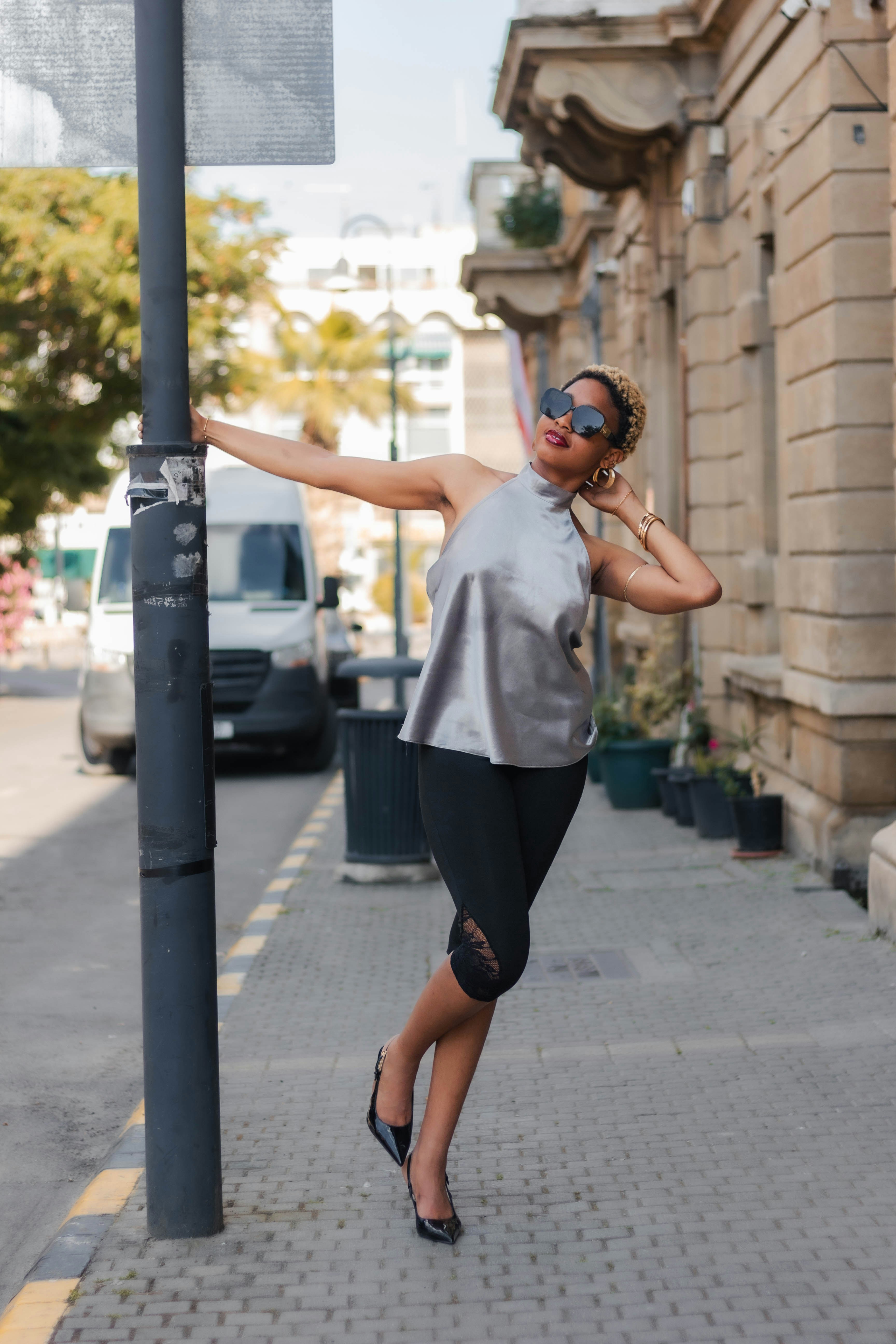Urban Poise: A Stylish Moment Against Classical Architecture