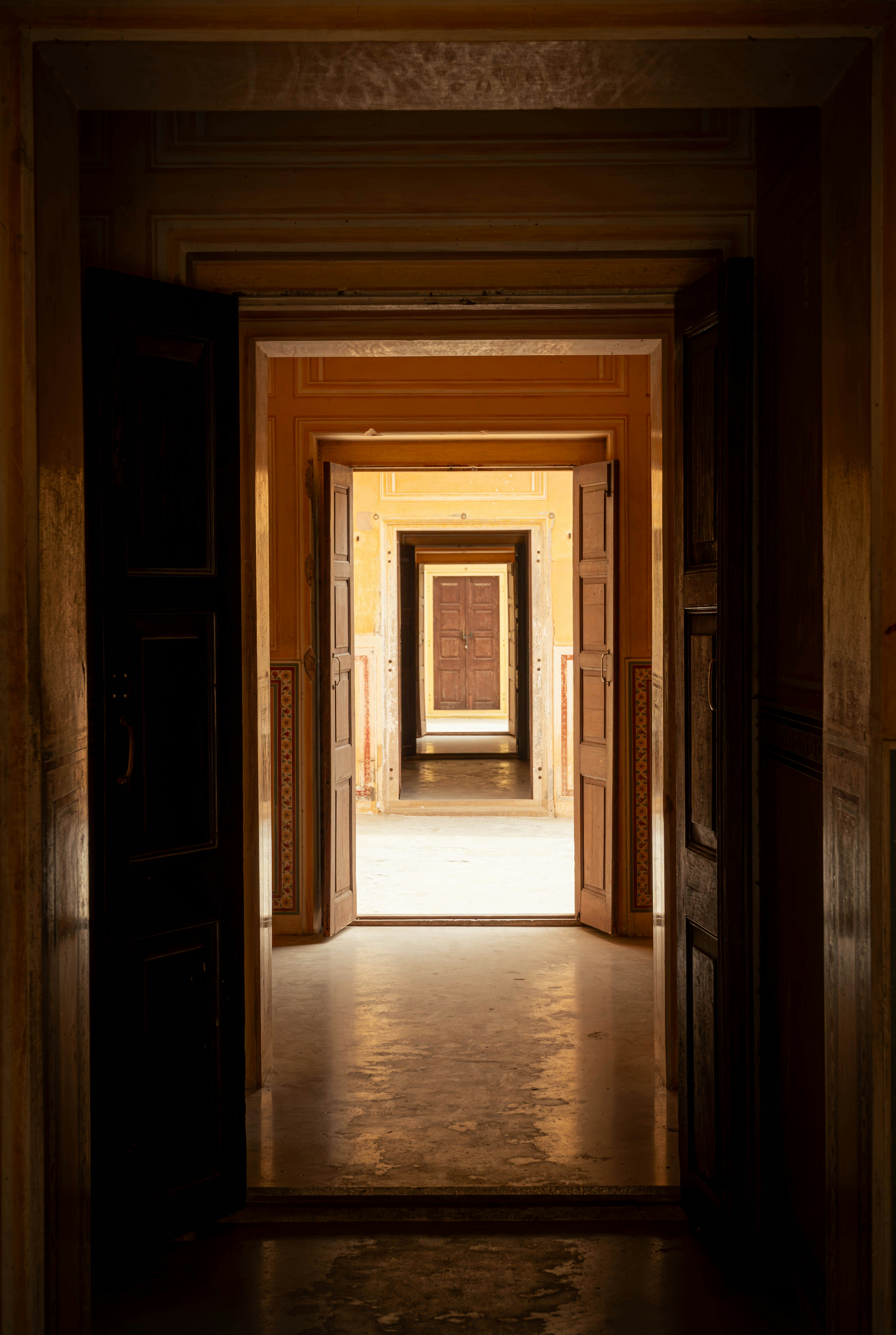 Echoes of a Long Corridor: Receding Doorways in Warm Light
