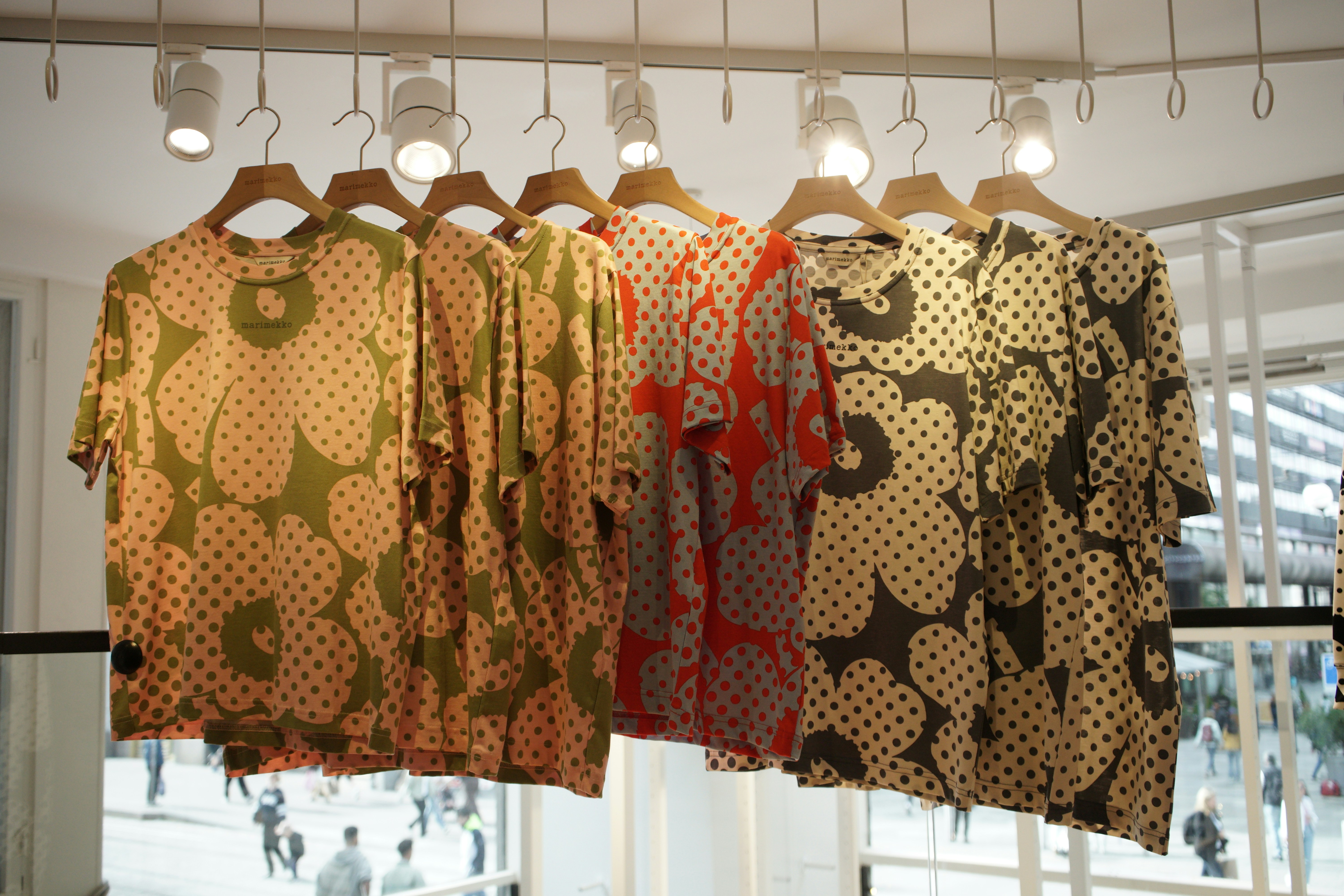 Mosaic of Dotted Blooms: Polka-Patterned Tees in a Sunlit Display