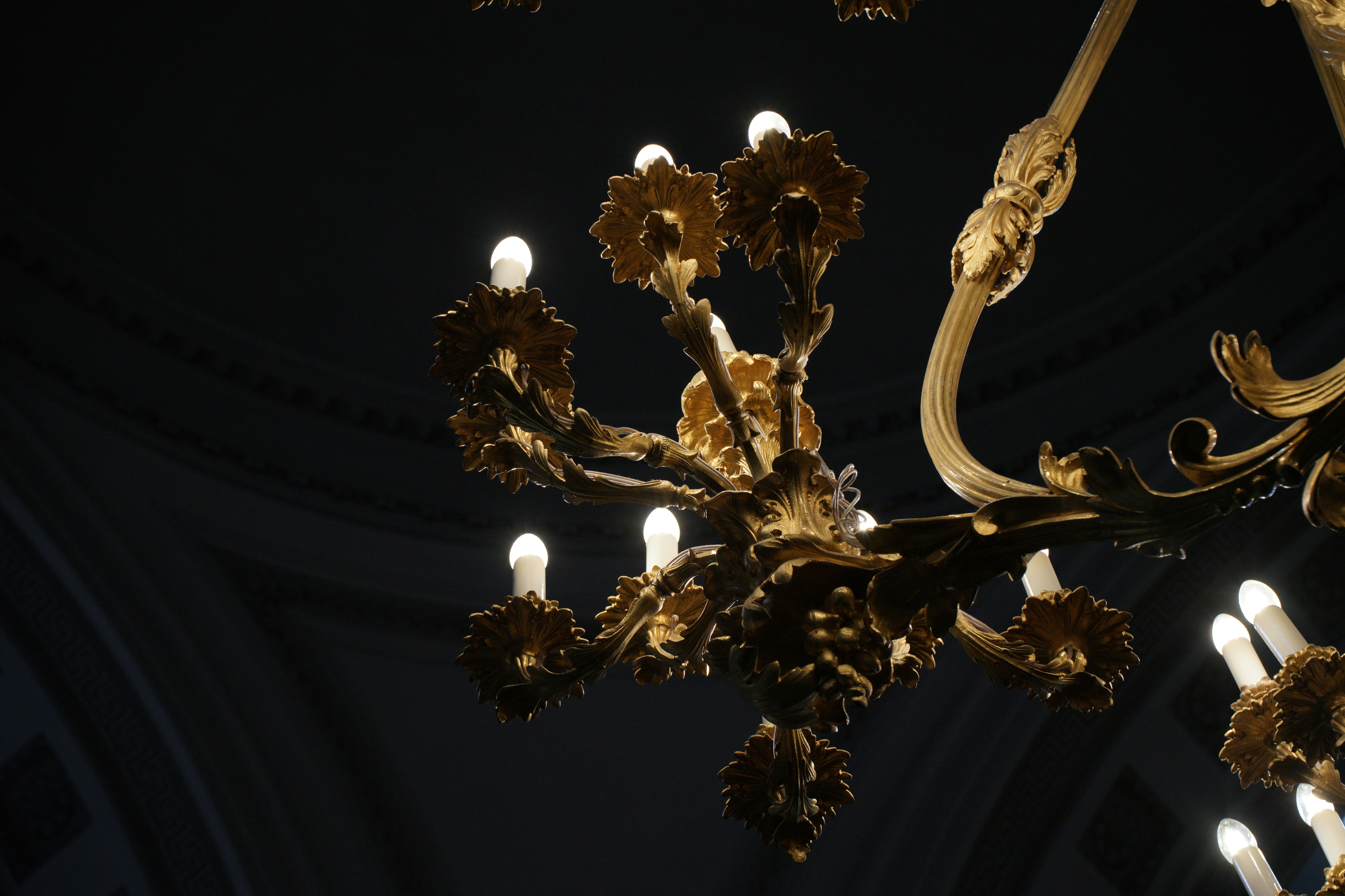 Golden Chandeliers: Lamplight Amid Dark Vaults