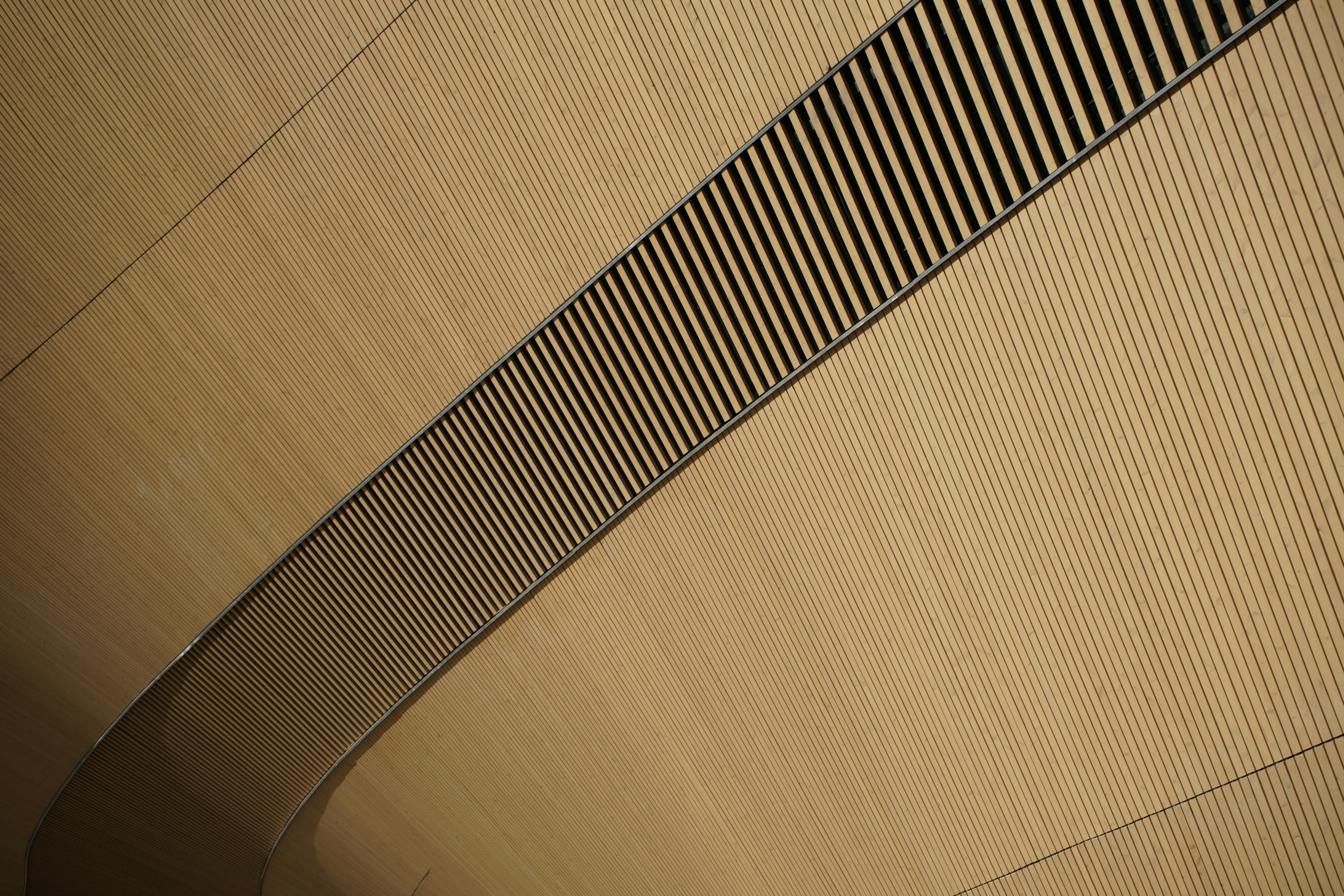 Curved Ventilation Slats Tangling Across Golden Paneling