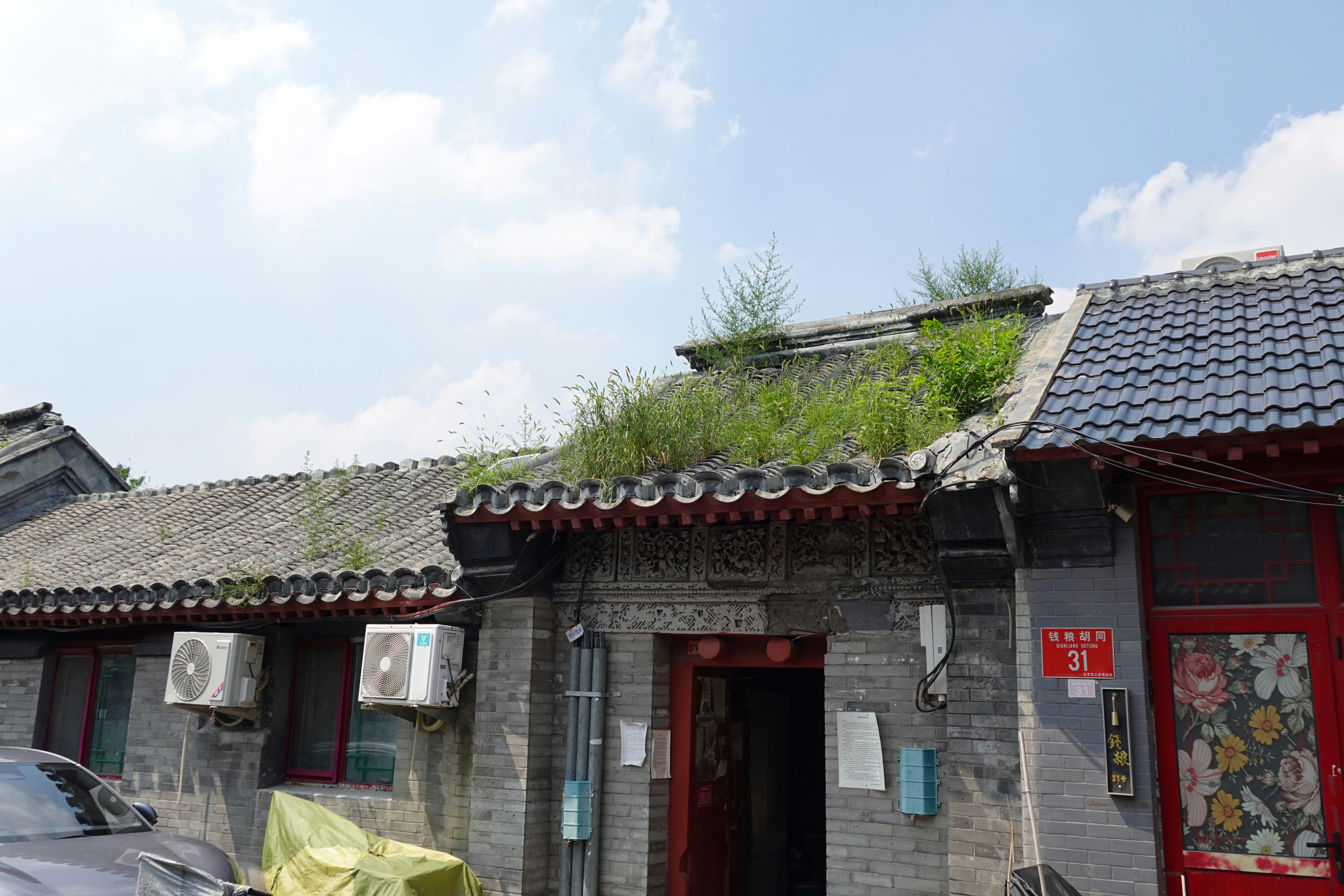 Terraced Rooflines and Red-Trimmed Facade Under a Blue Sky