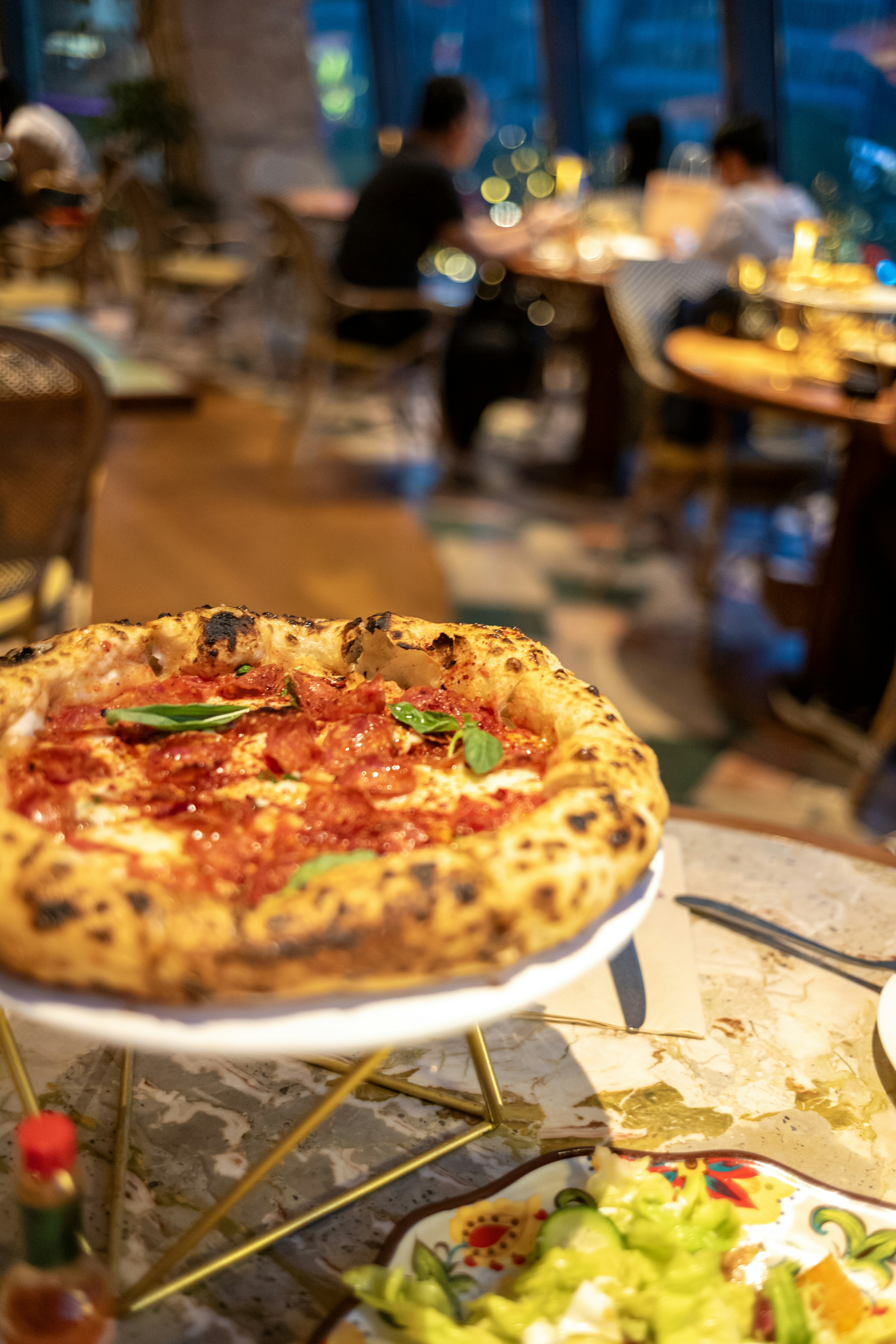 Pizza in Focus: A Late-Night Table Scene with a Prominent Pepperoni Pie