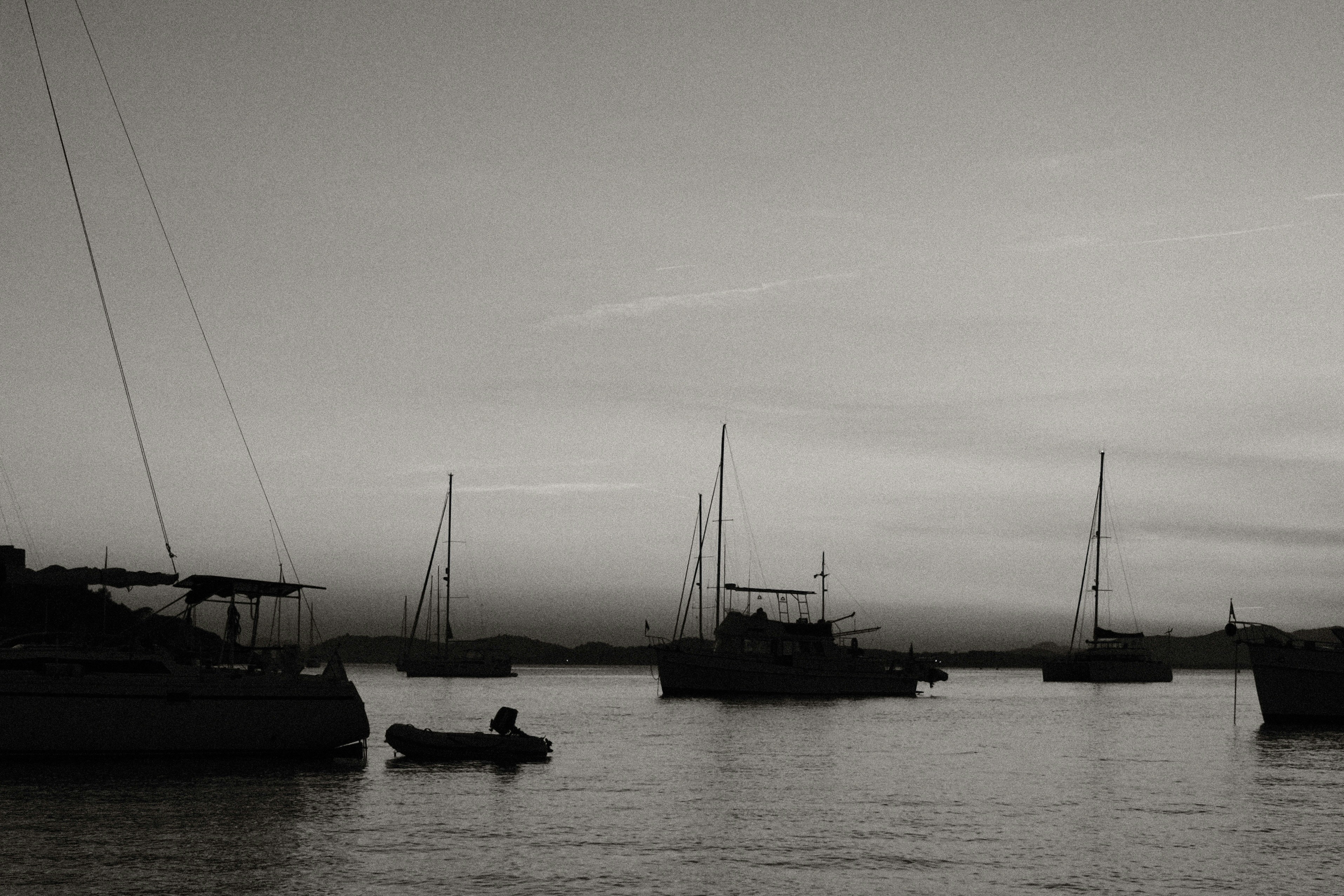 Silhouette Harbor: Boats Rest at Dusk in Quiet Waters