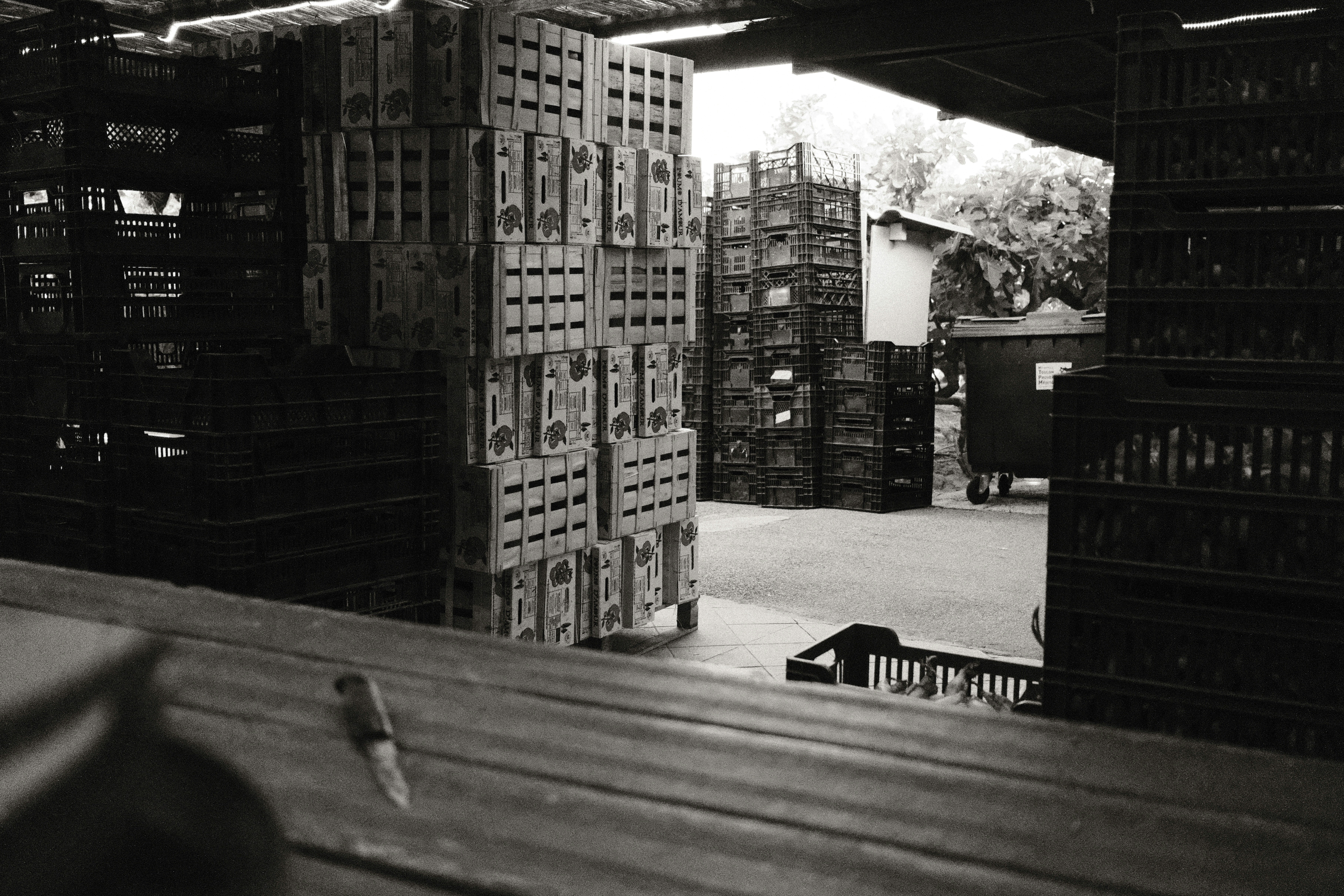 Stacks of crates in a dim warehouse doorway