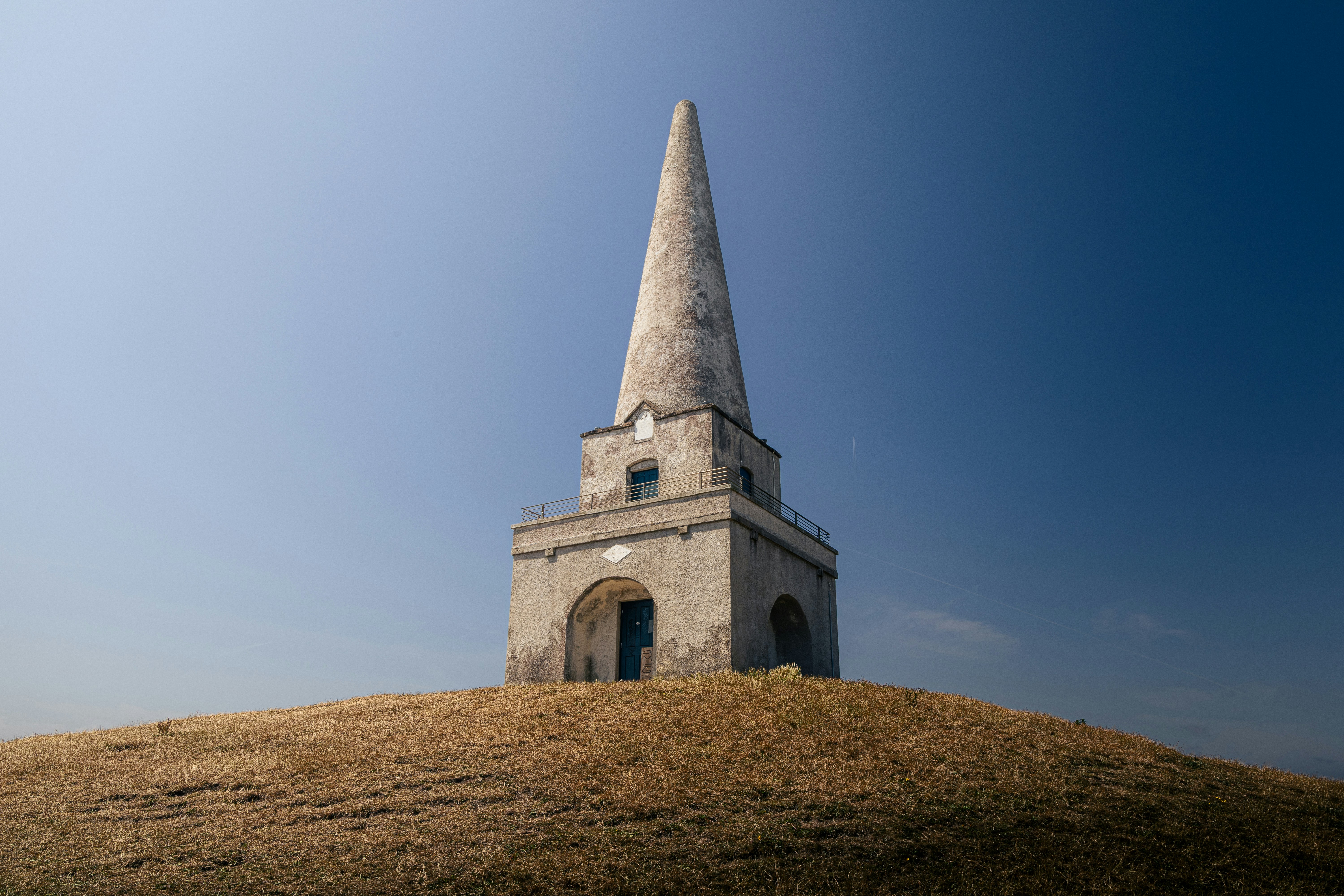 Conical Spire Rising from a Hillside Monolith
