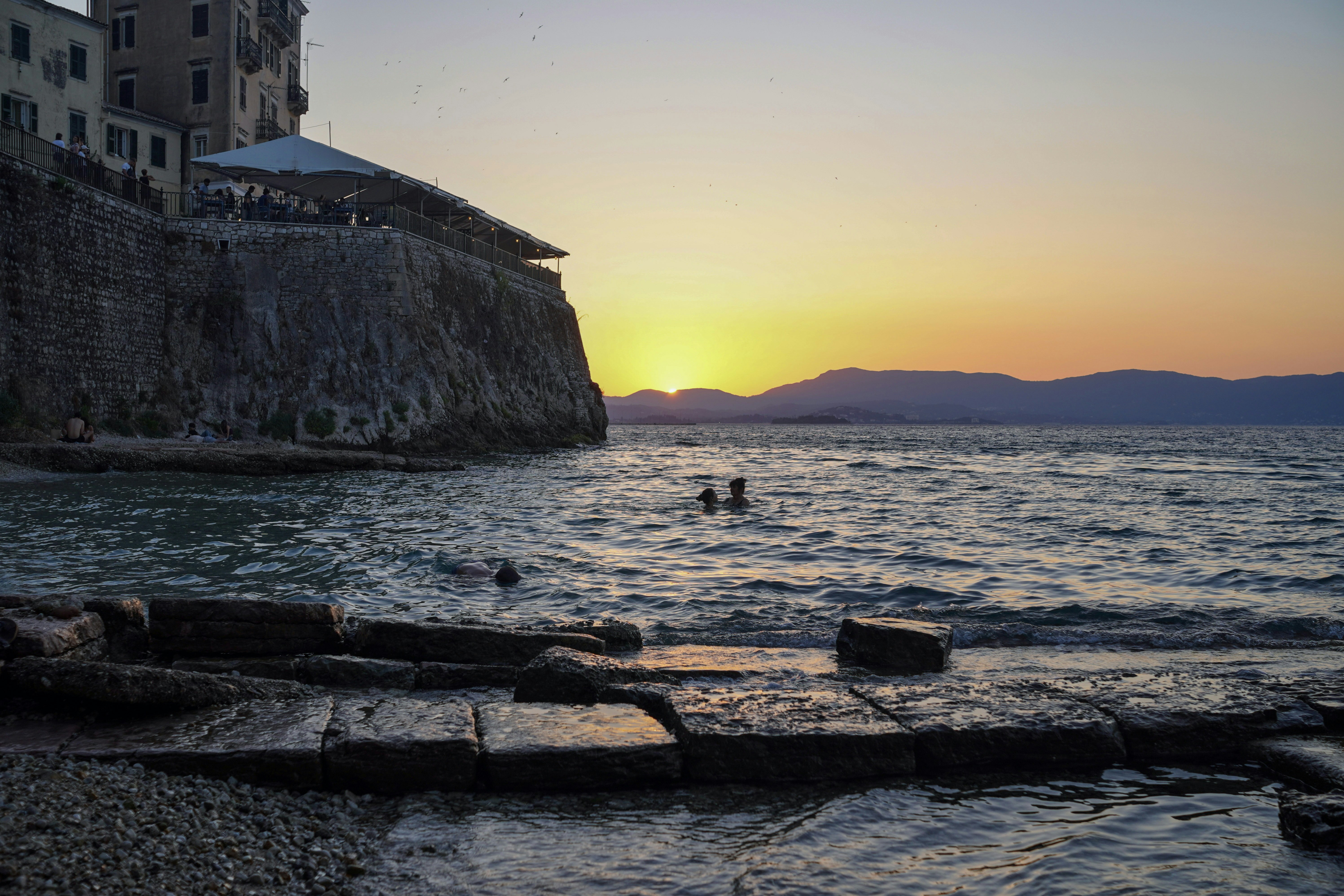Sunset Over the Quiet Sea: A Waterfront Terrace at Dusk
