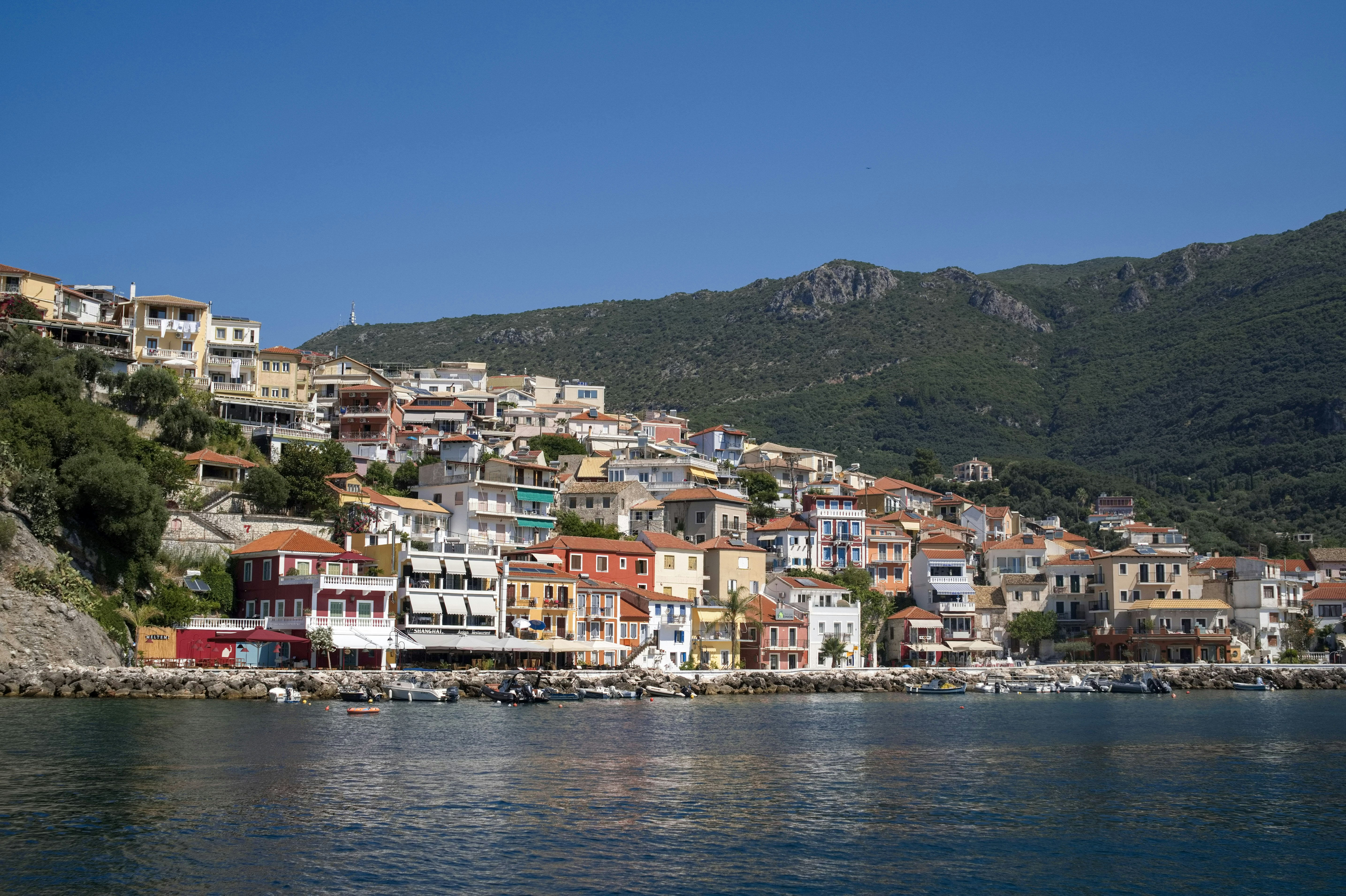 Sunlit Italian harbor village spilling over the waterline