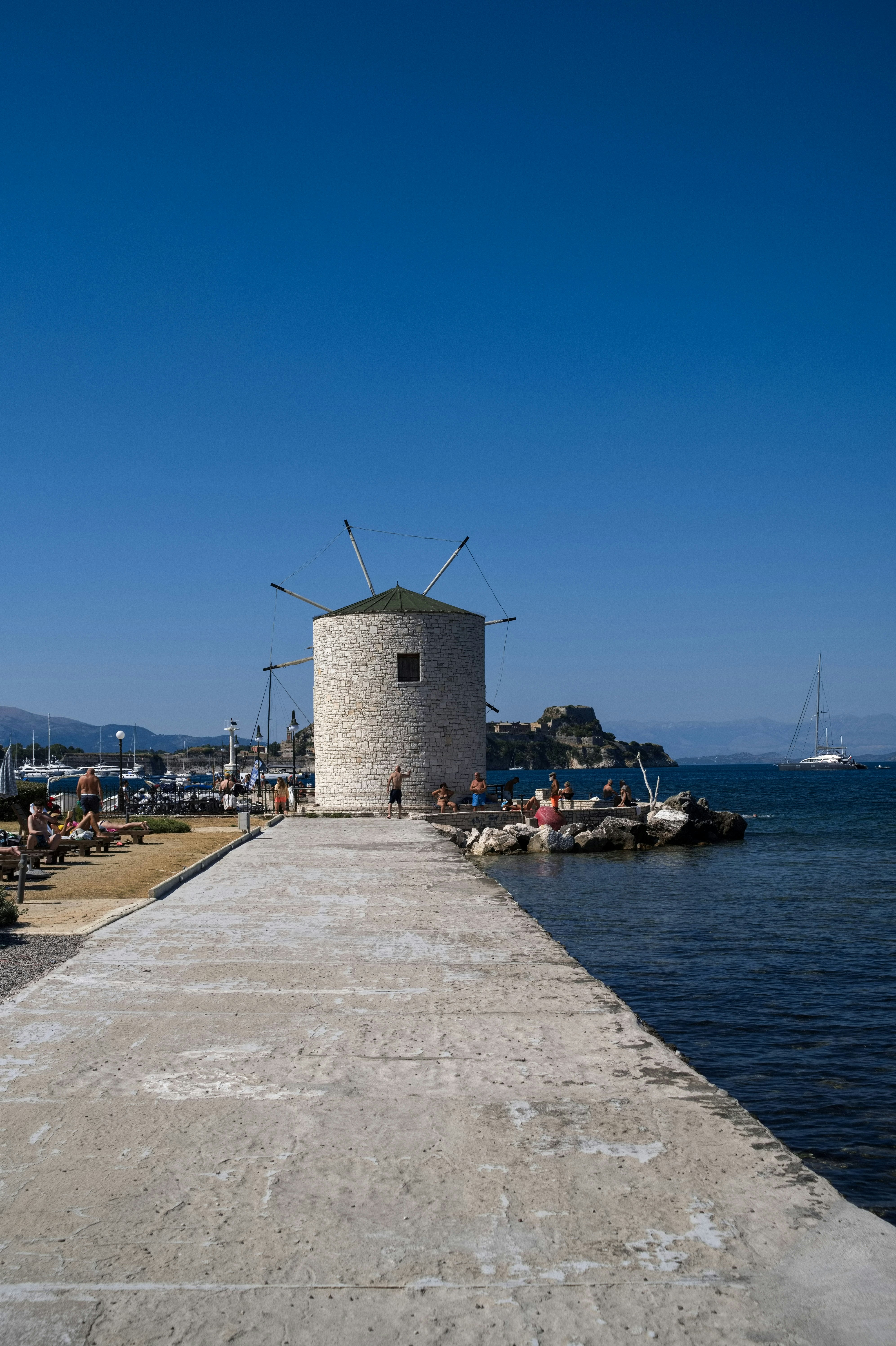 Stone Windmill at the Pier: A Quiet Coastal Passage