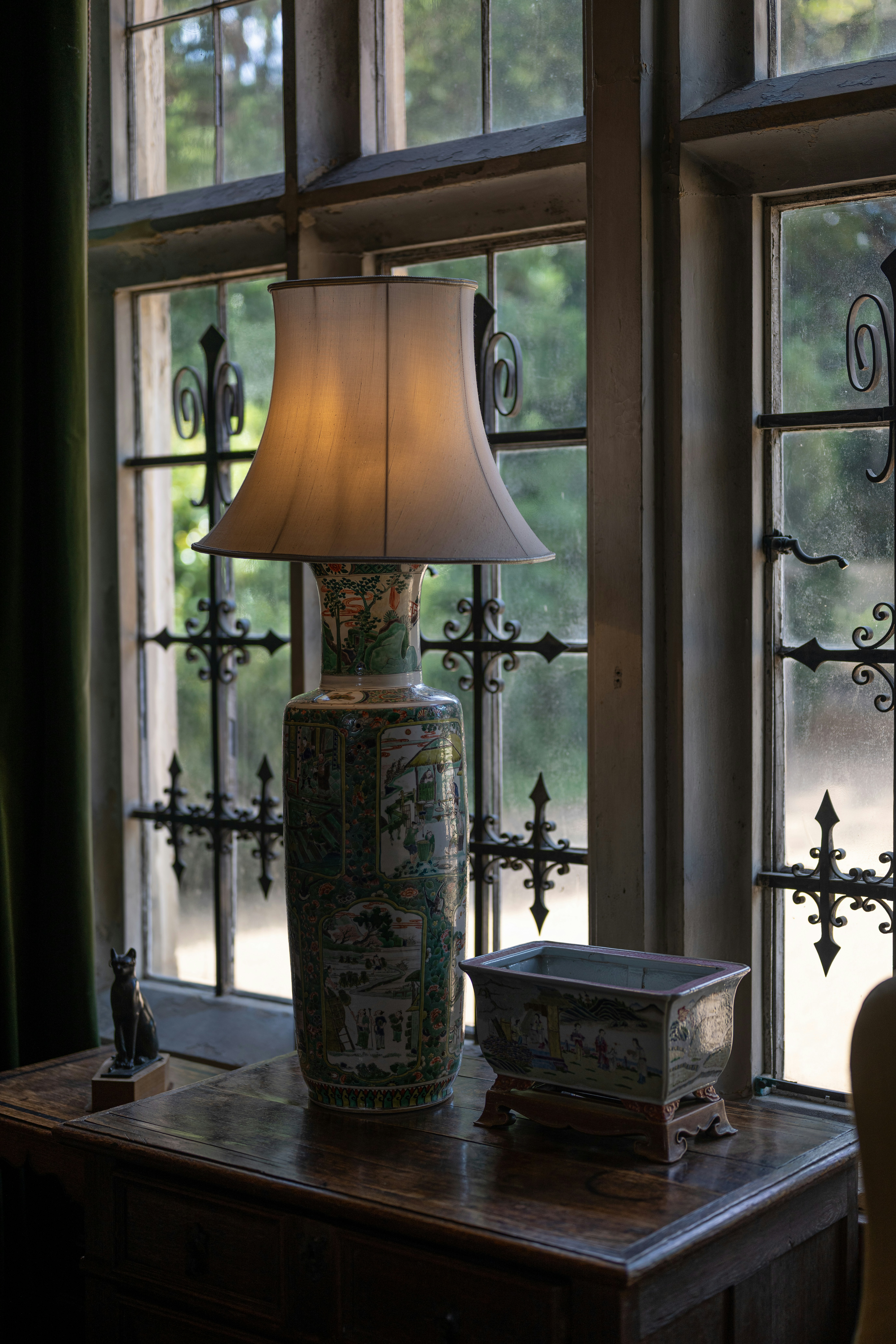 Quiet Glow: A Ceramic Lamp Silhouette by The Window