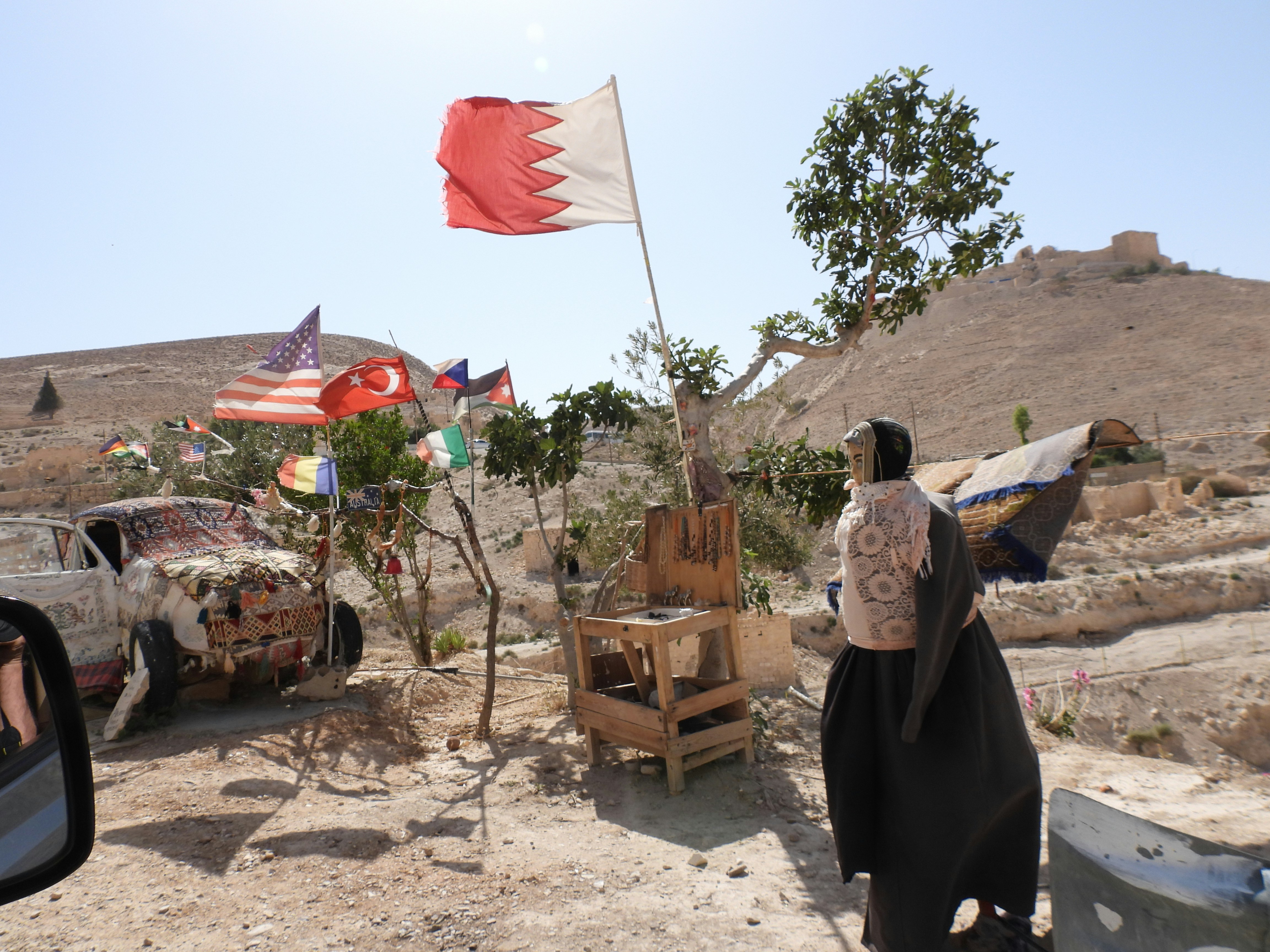 Flags, Sand, and a Quiet Refuge: A Far-Flung Market Scene