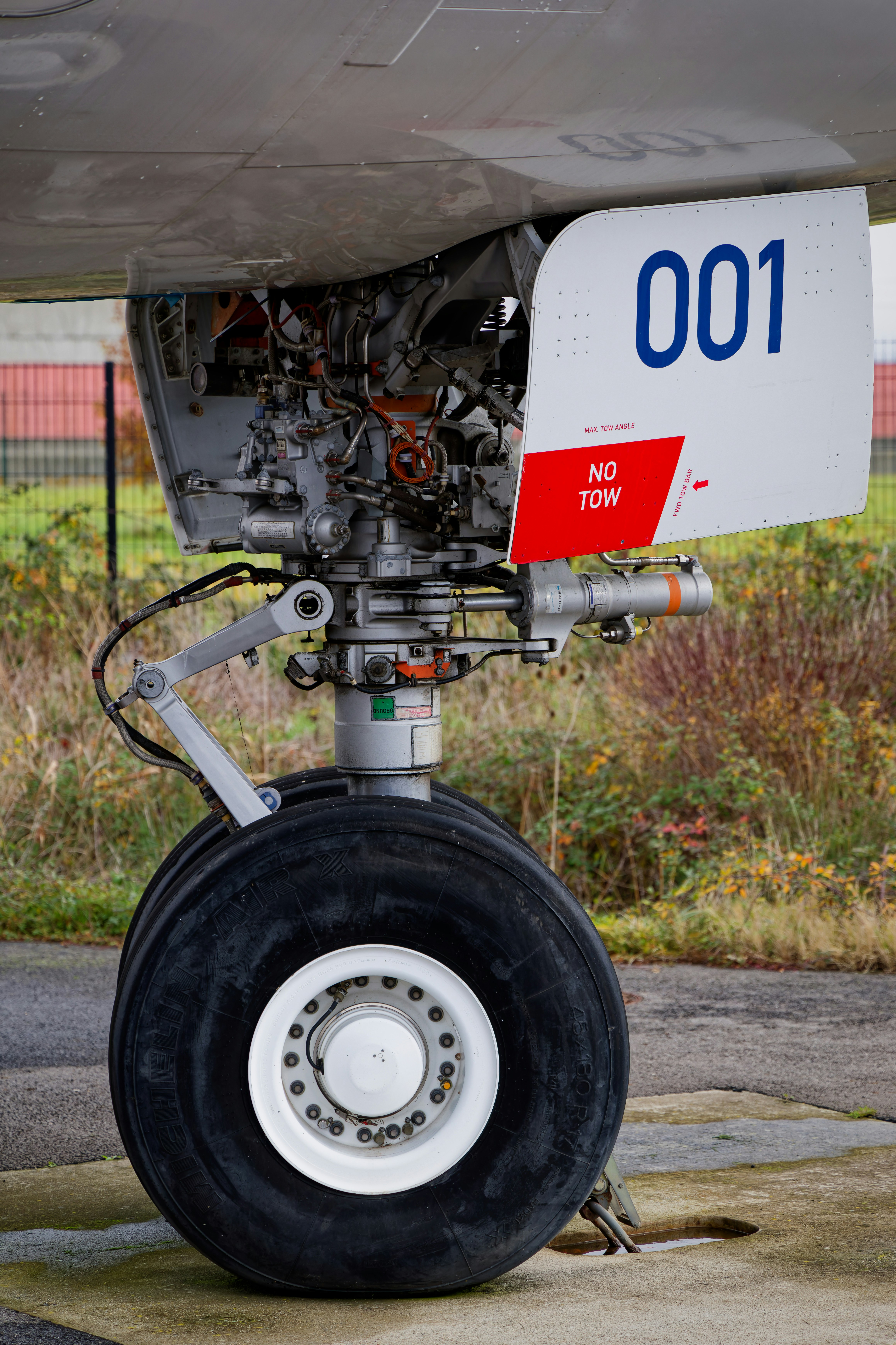 Jet-black tire and exposed mechanism under aircraft wing