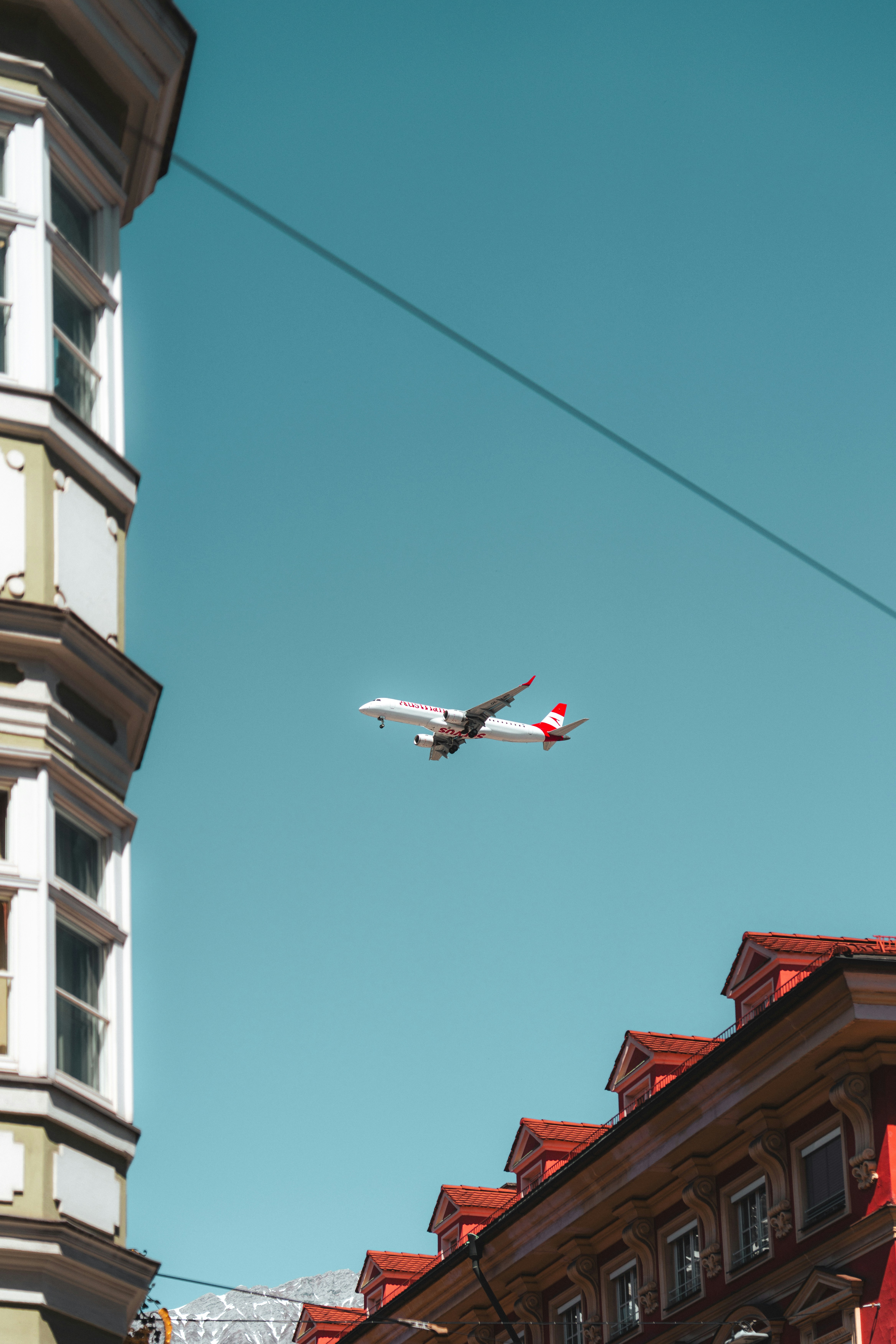Airliner in a Clear Cityscape: A Moment Above Rooftops