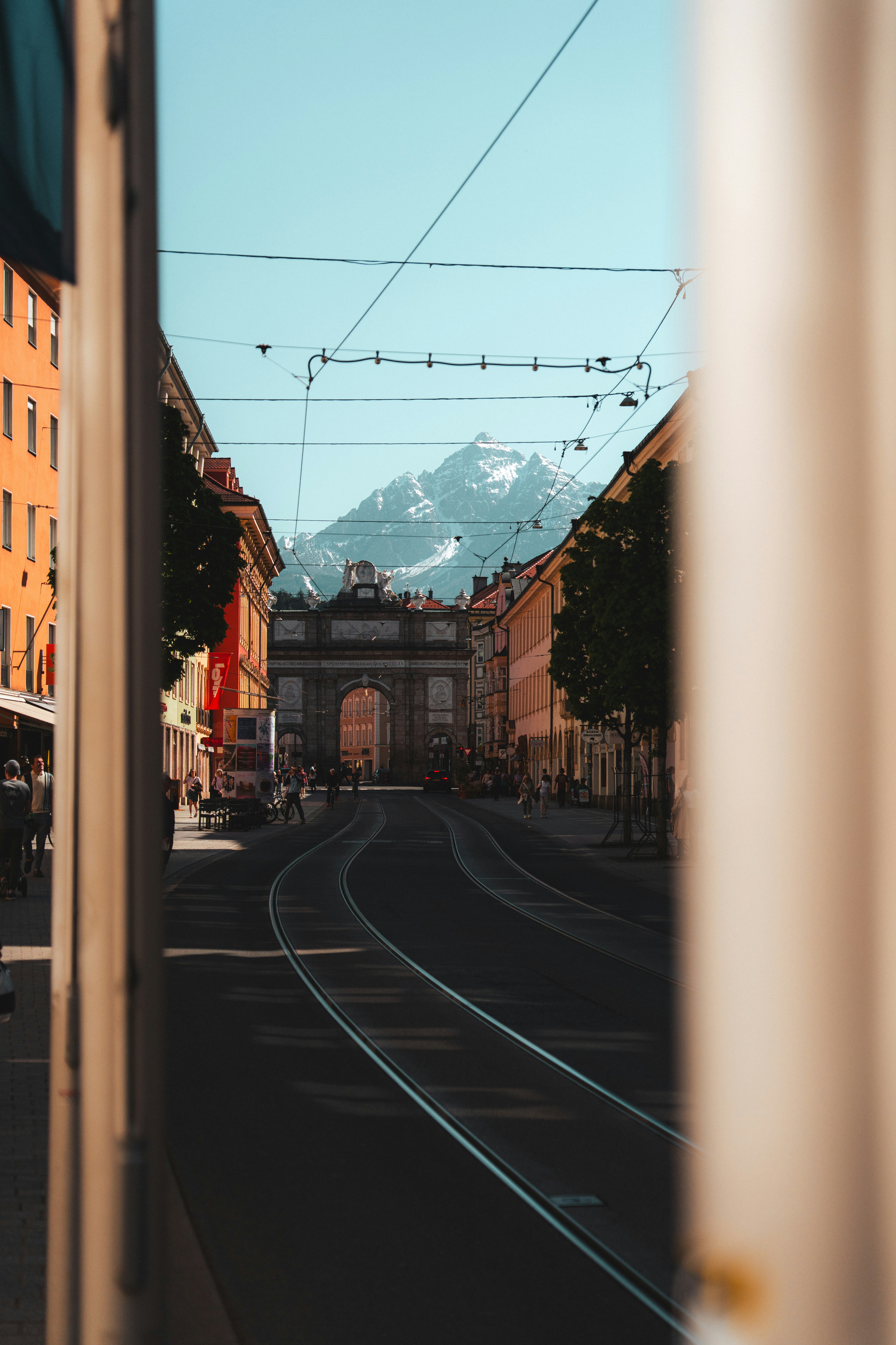 Archway to the Alps: A City Street Framed by Rails
