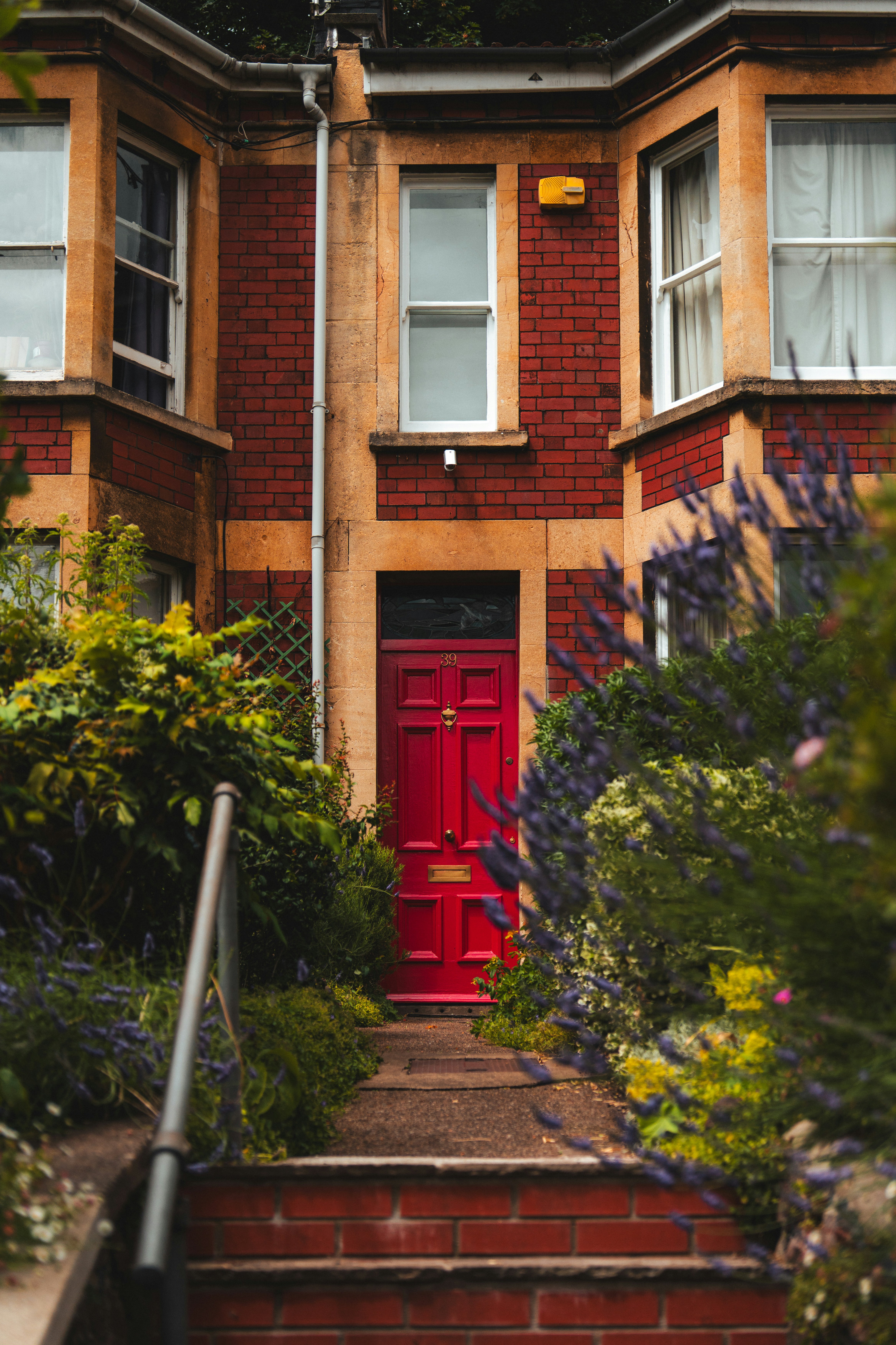 Crimson Doorway Framed by Garden Tiers