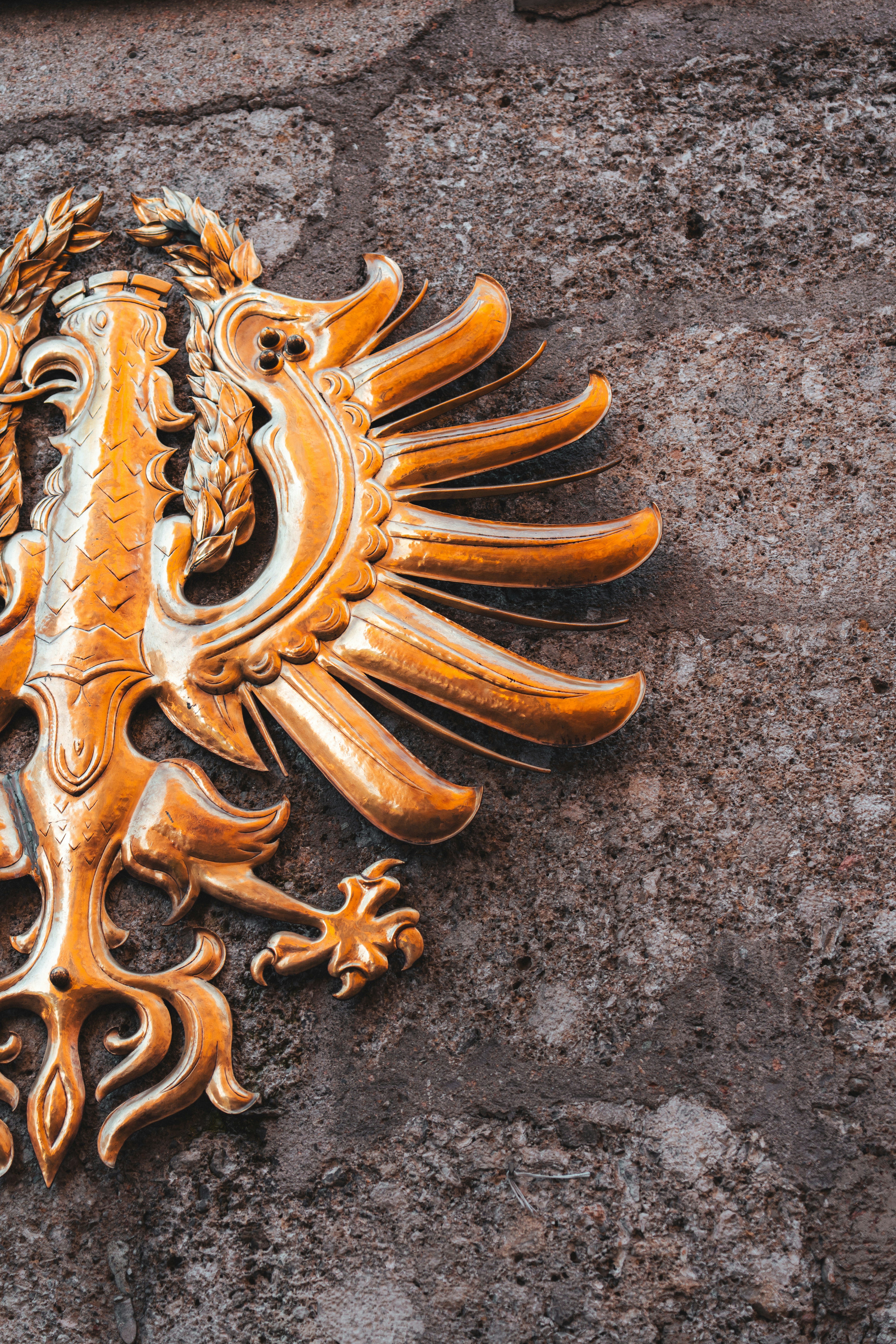 Ornate Bronze Emblem Adorned on Weathered Stone